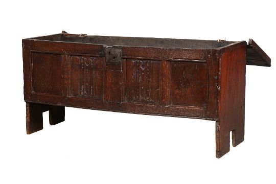 A 17TH CENTURY LINEN FOLD PLANK COFFER. The rectangular one piece top ...
