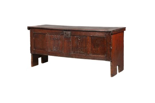 A 17TH CENTURY LINEN FOLD PLANK COFFER. The rectangular one piece top ...