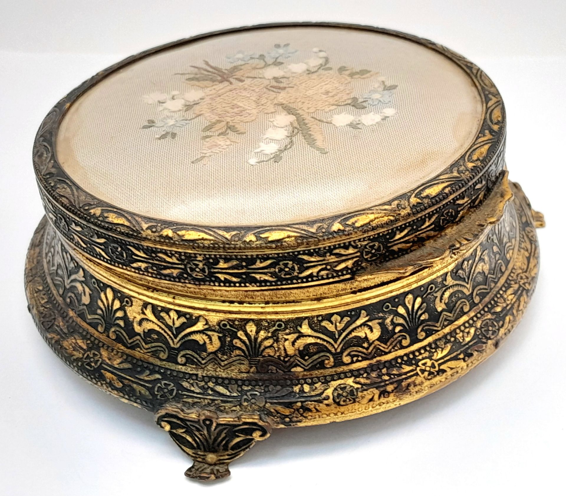 A vintage gilt metal circular jewellery trinket box with mirror inside ...