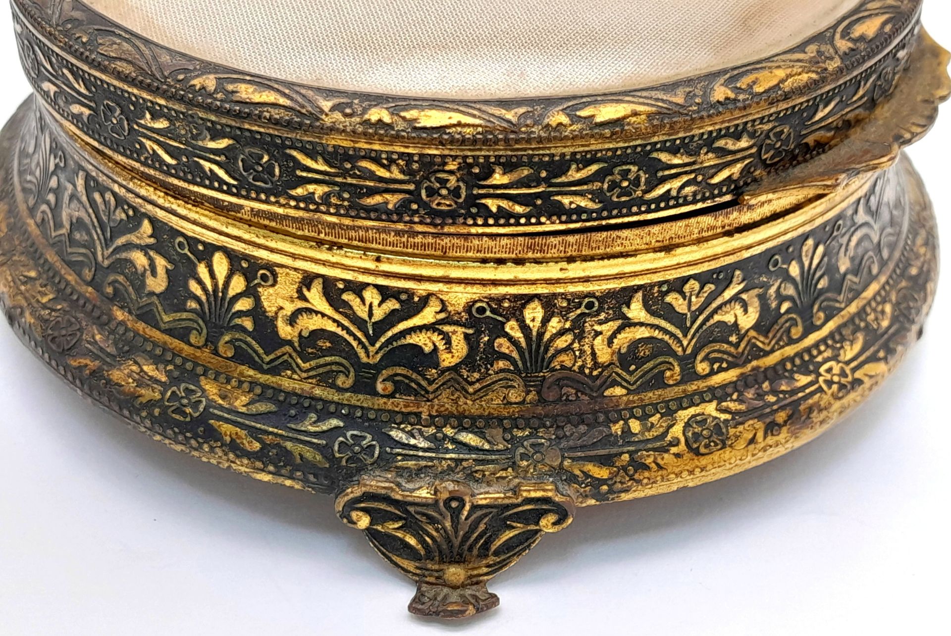 A vintage gilt metal circular jewellery trinket box with mirror inside ...