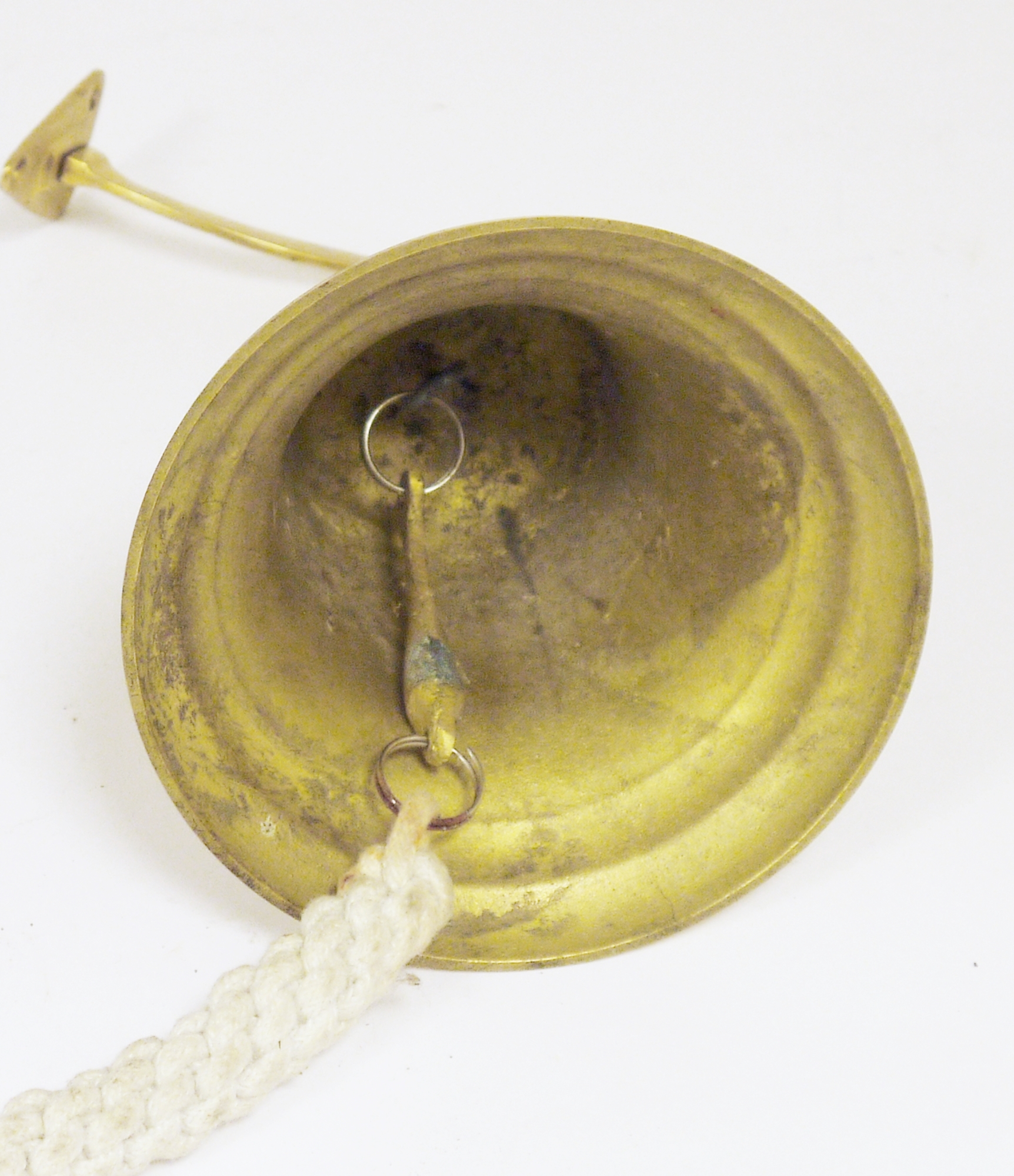 Reproduction brass ship's bell on a swinging wall bracket, the clapper ...