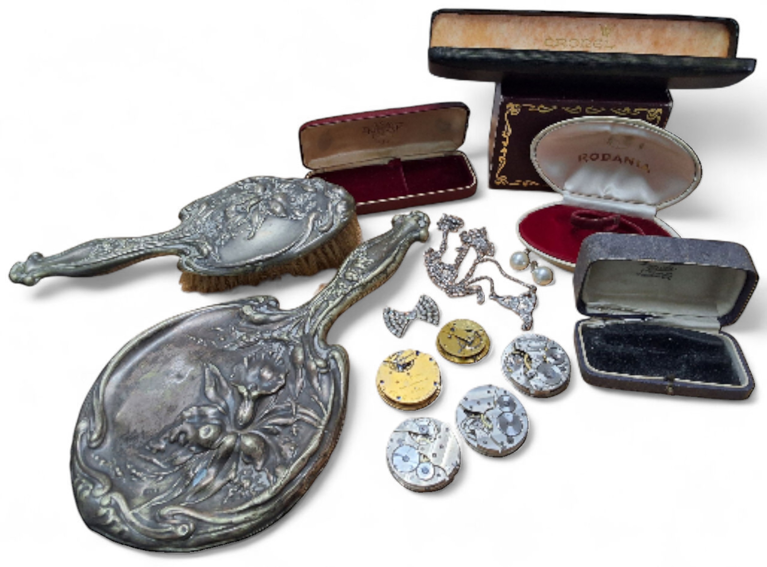 An Art Nouveau EPNS hand mirror and brush, embossed in relief with Iris ...