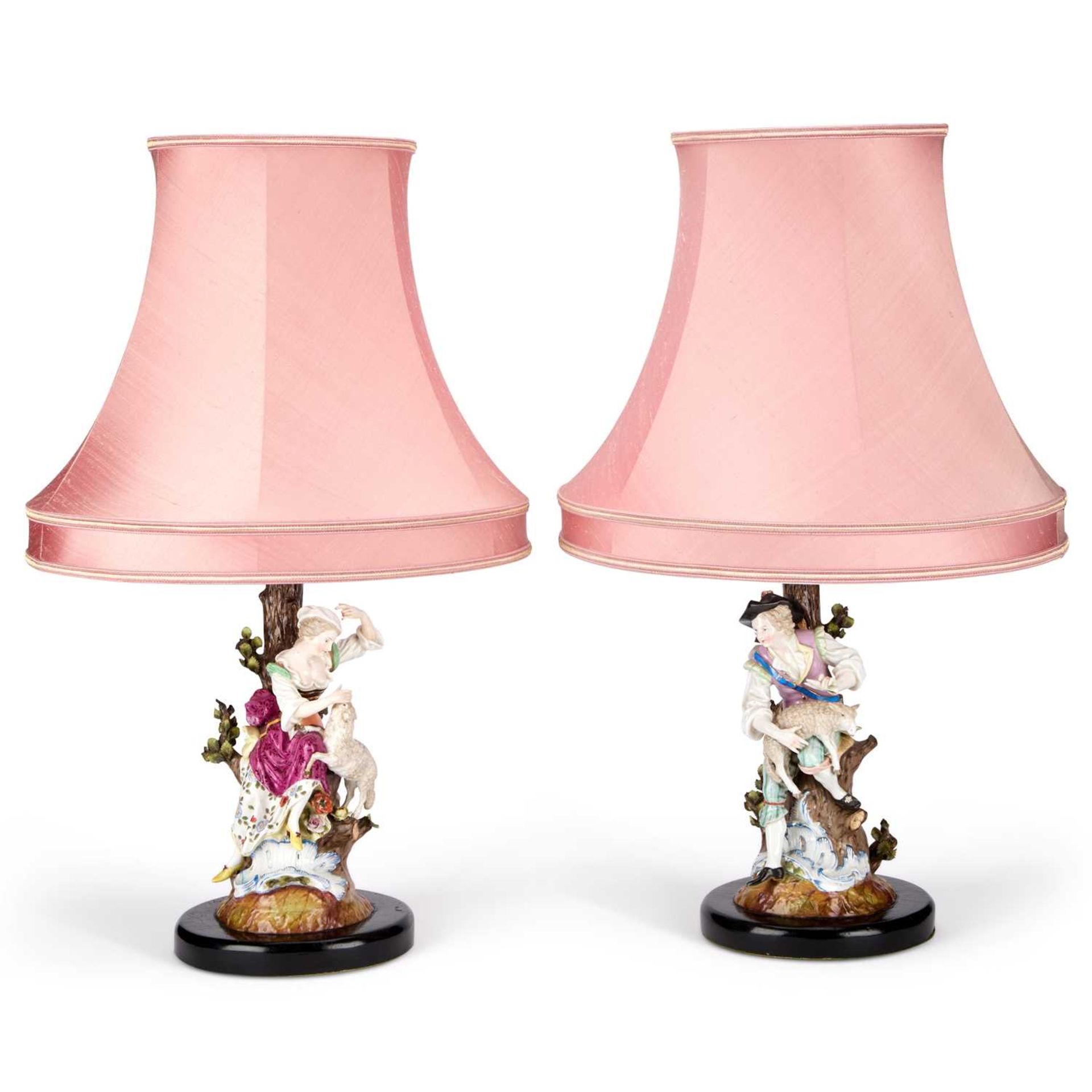 A PAIR OF CONTINENTAL PORCELAIN FIGURAL TABLE LAMPS modelled as a ...