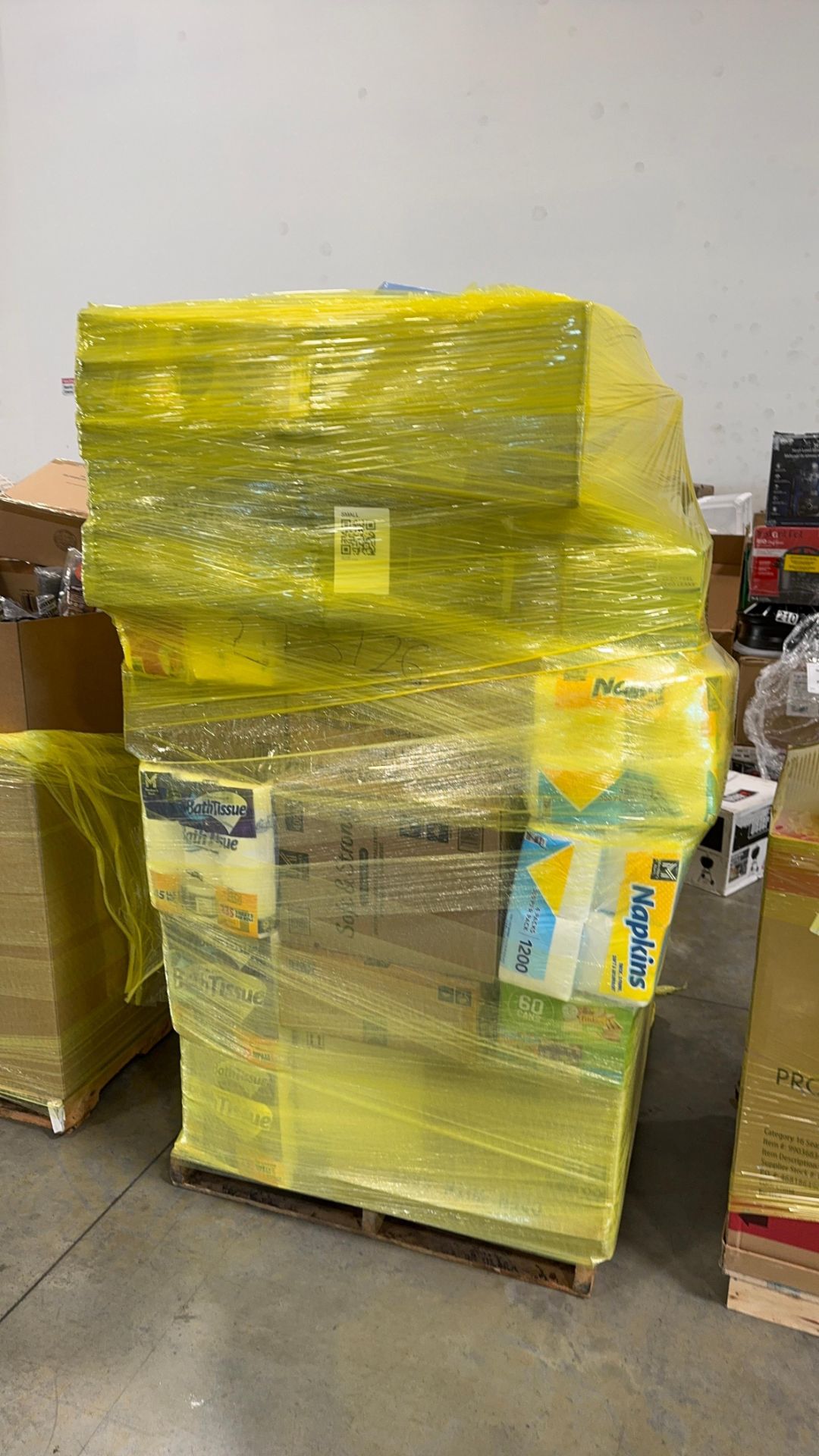 tall pallet full of paper towels, toilet paper, Crock-Pot diapers and more