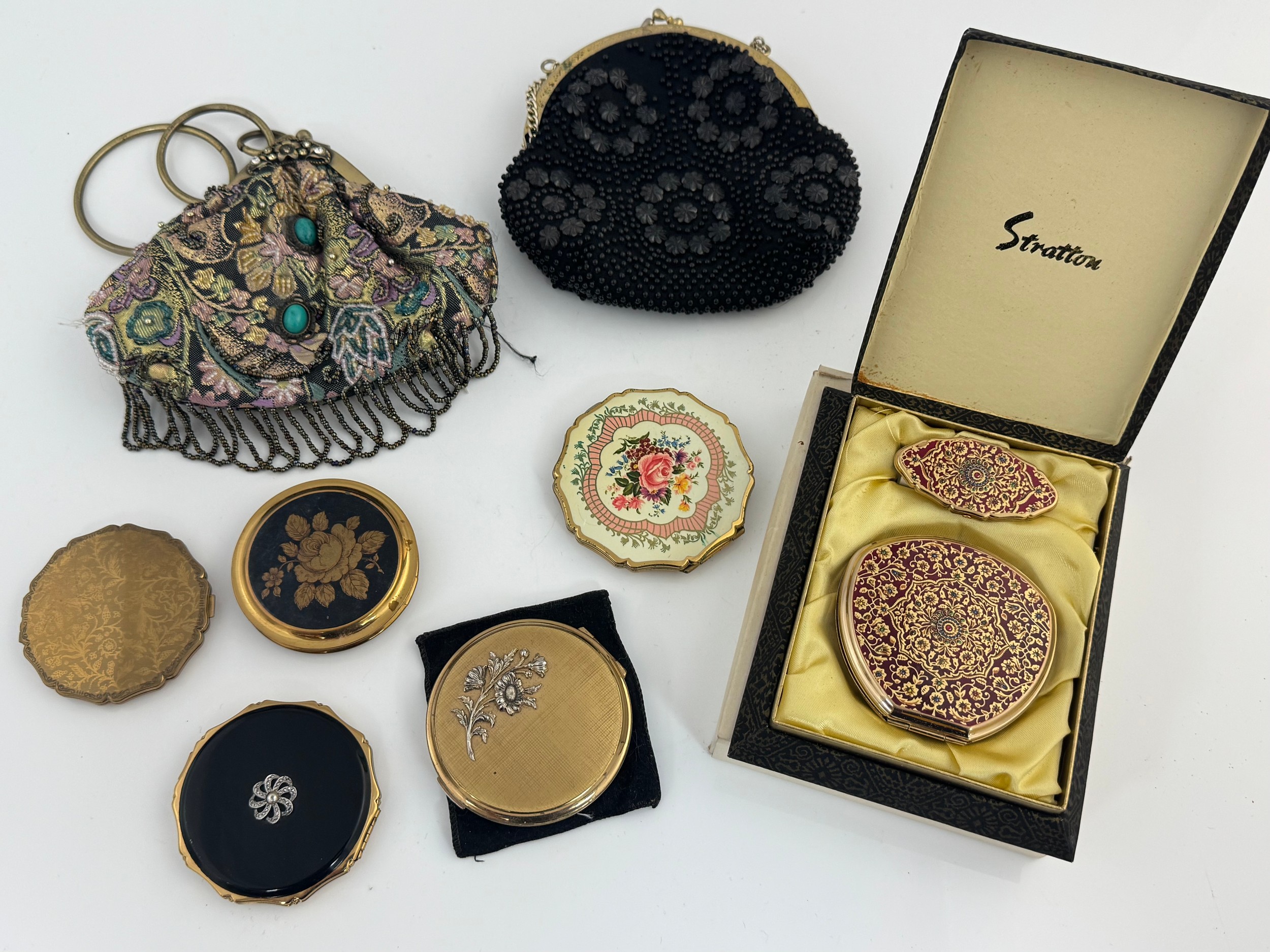 A collection of compacts including a boxed Stratton compact and ...
