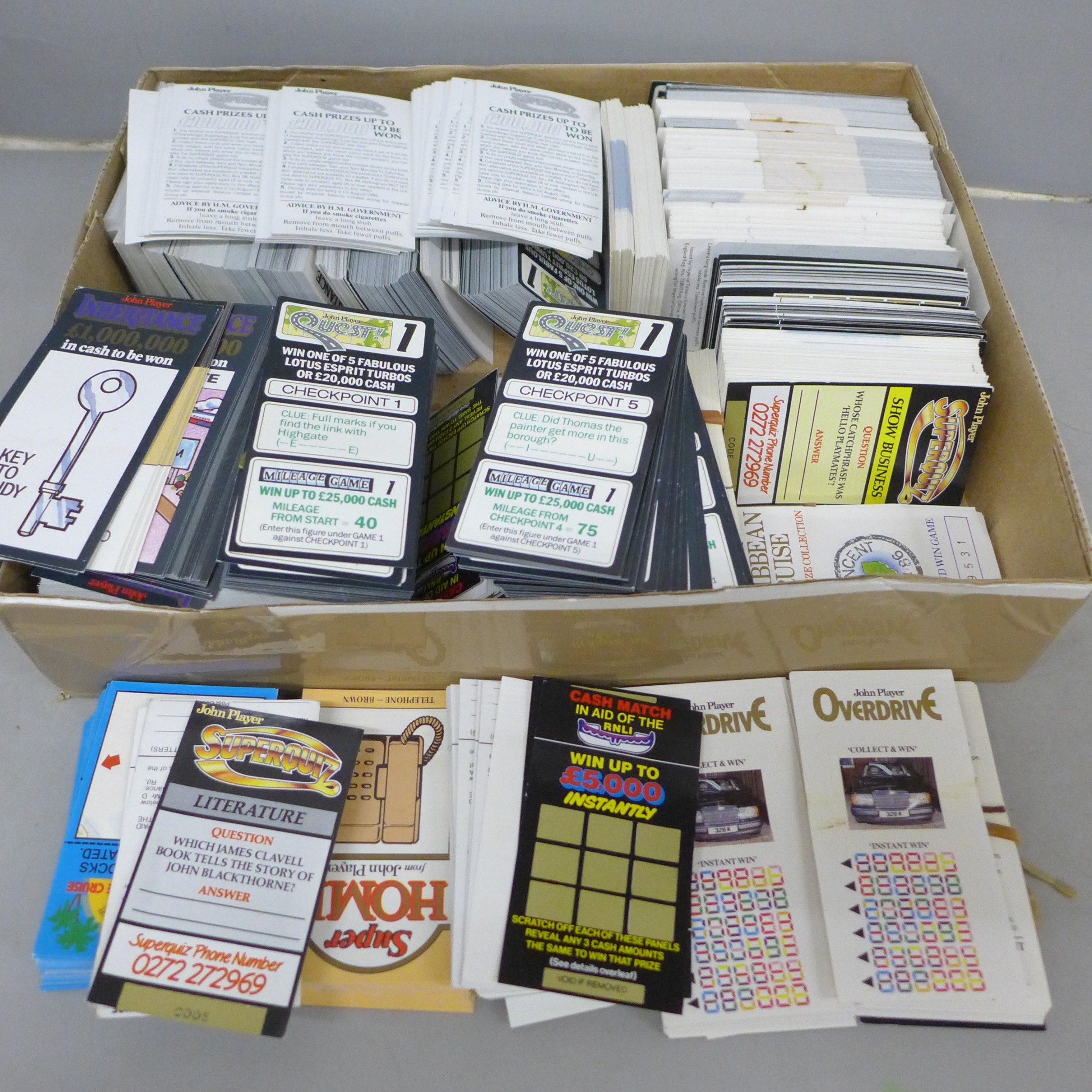 A box containing a collection of vintage cigarette pack coupons ...