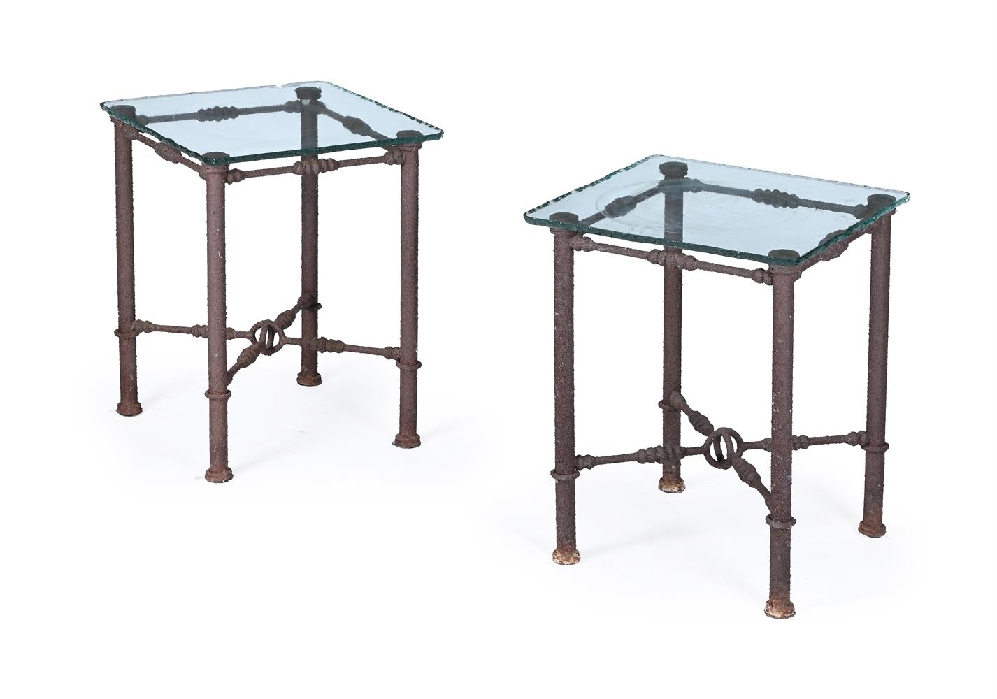 A pair of cast iron garden/conservatory tables with glass tops, each ...