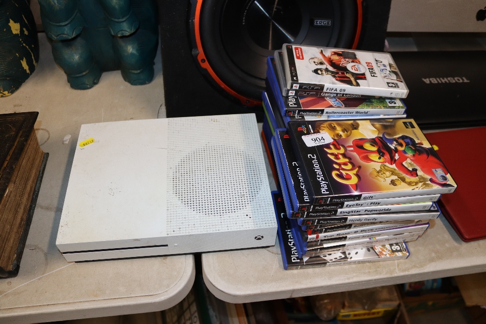 An Xbox 1 and a collection of PS2 games - sold as seen