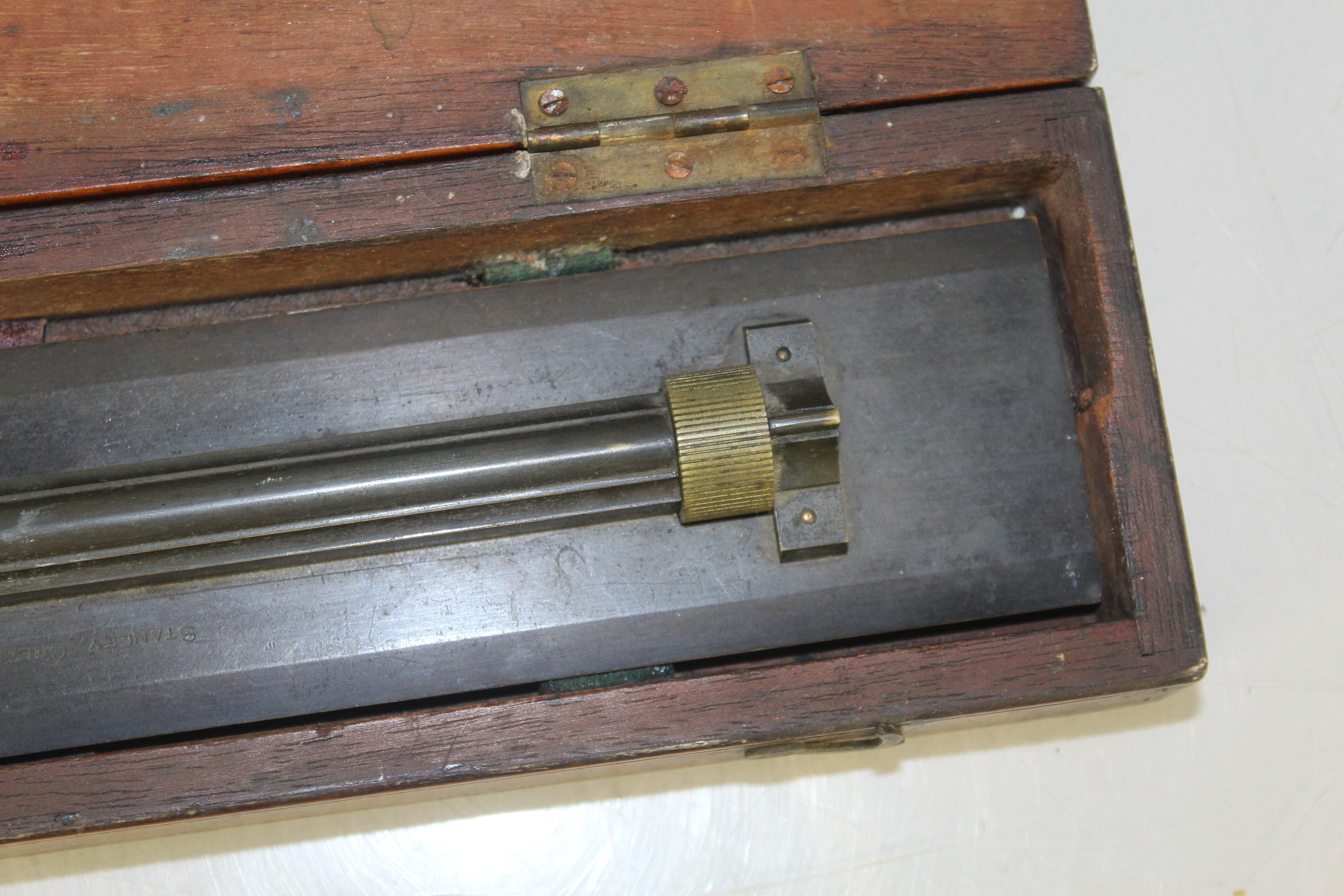 A 19th Century brass parallel roll in mahogany case