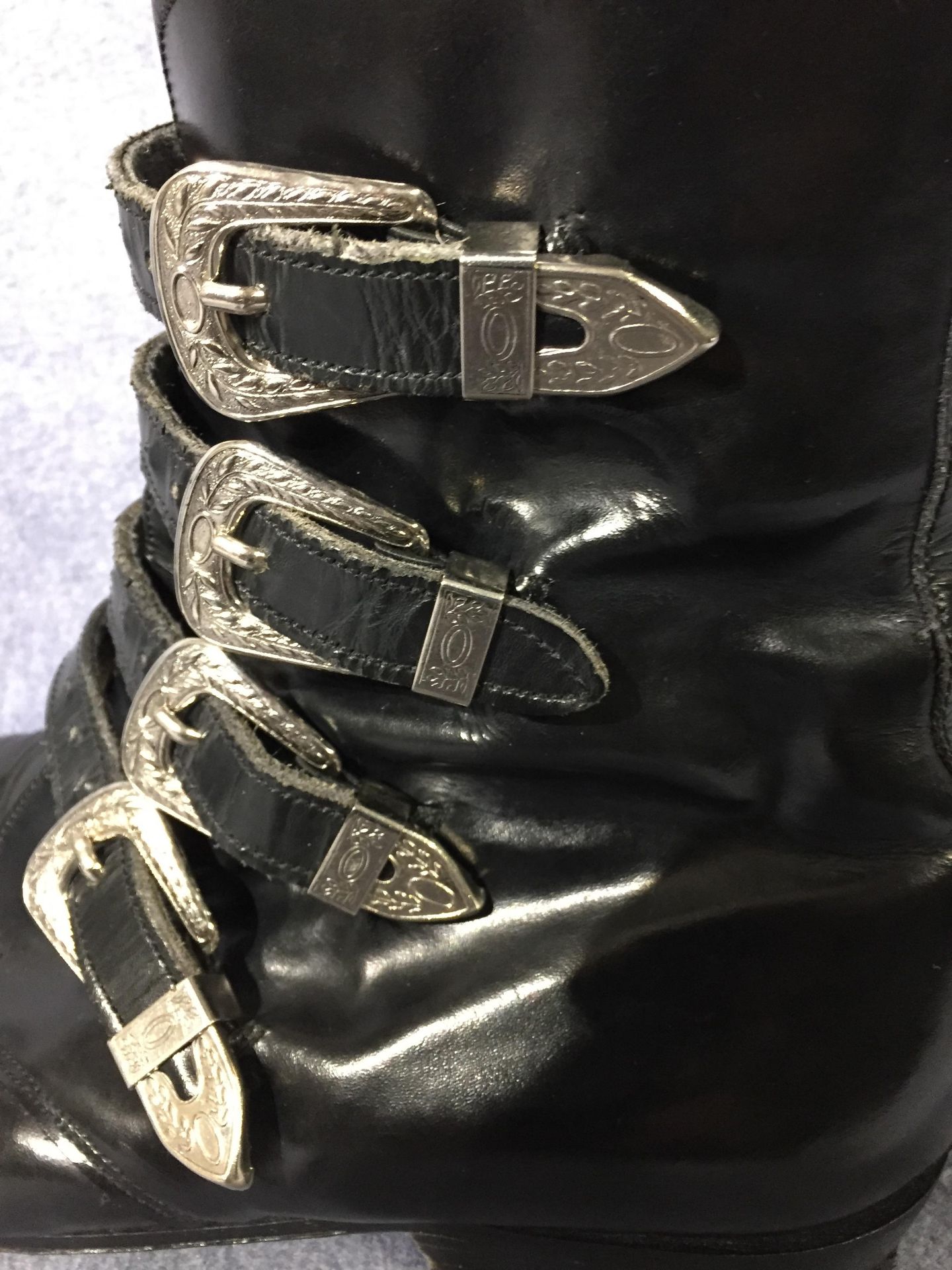 Pair of black leather winklepicker ankle boots each with four silver ...
