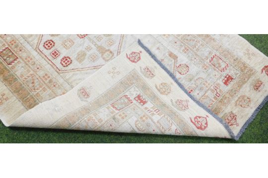 A Persian Scrab cream ground runner, the central field with three ...