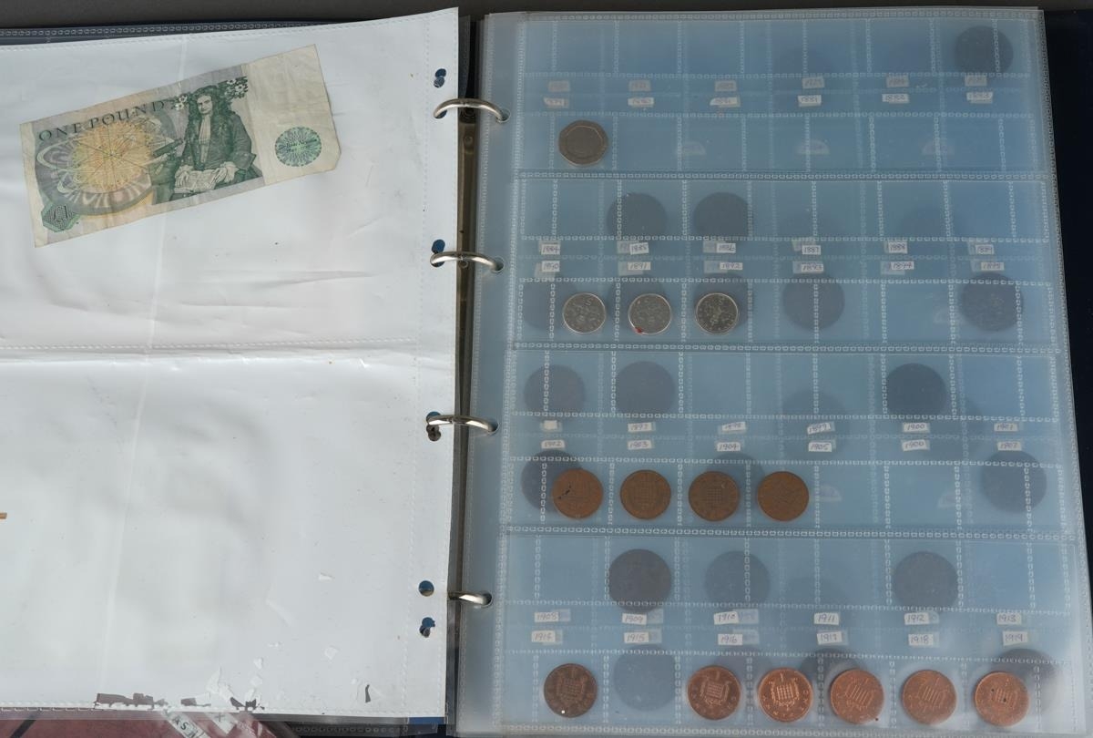 A coin album containing various British coins and 2 banknotes. Three ...