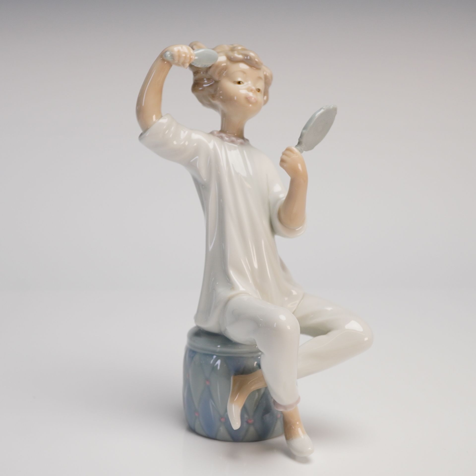 A single glazed porcelain figurative sculpture by Lladro, titled "Girl ...