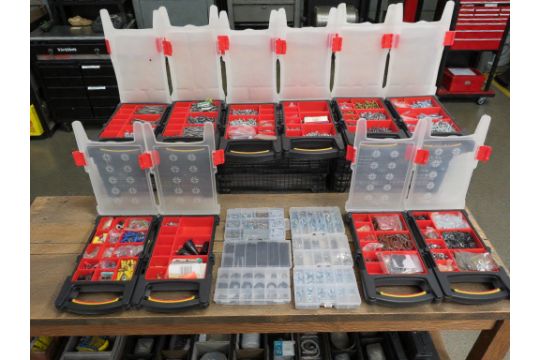 Sixteen storage organizer boxes with compartments containing assorted ...