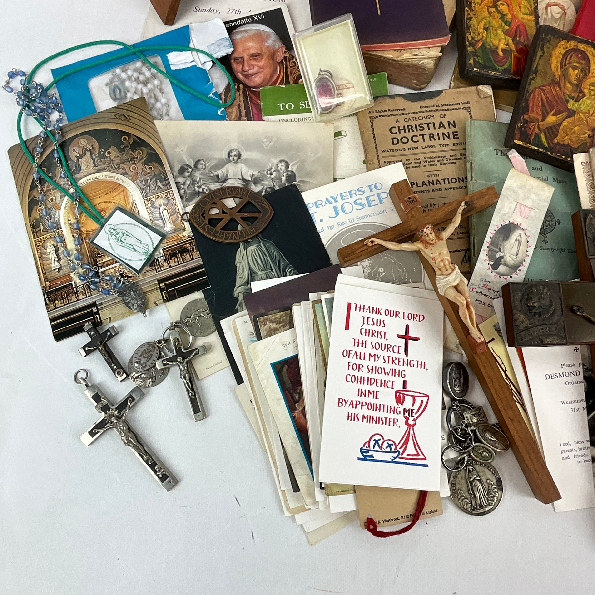 A collection of religious items to include Holy Relic of St Pius X with ...