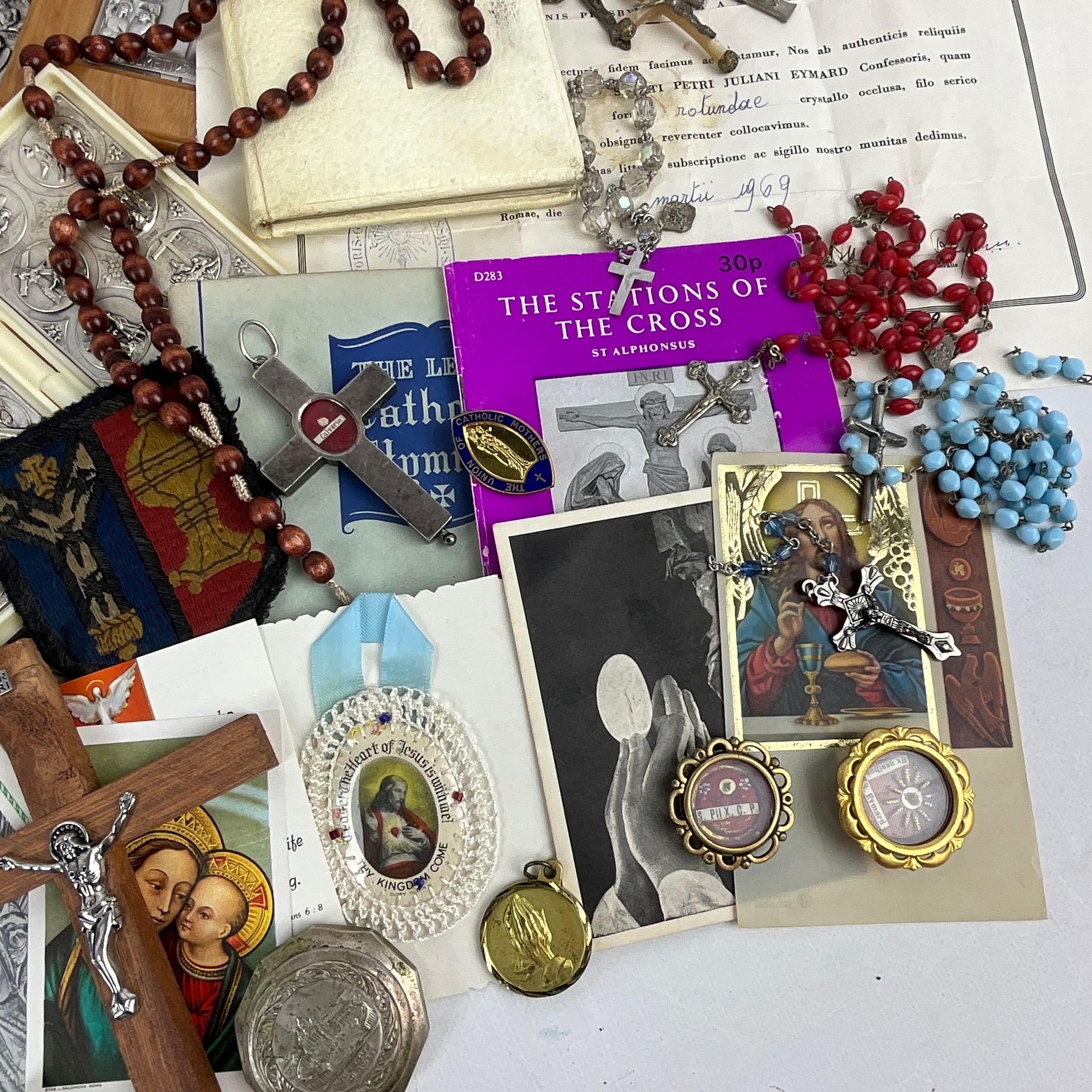 A collection of religious items to include Holy Relic of St Pius X with ...