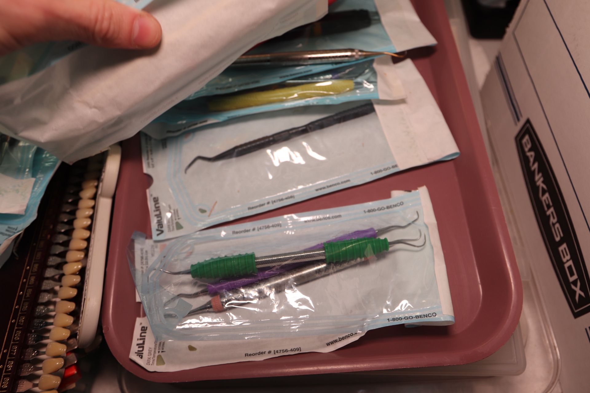 Contents of right side of tabletop including various dental instruments ...