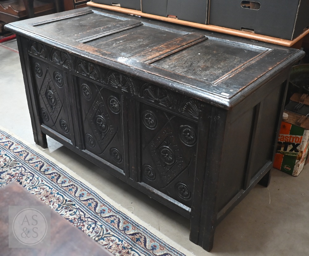 A large 18th century and later carved oak coffer, traditional panelled ...