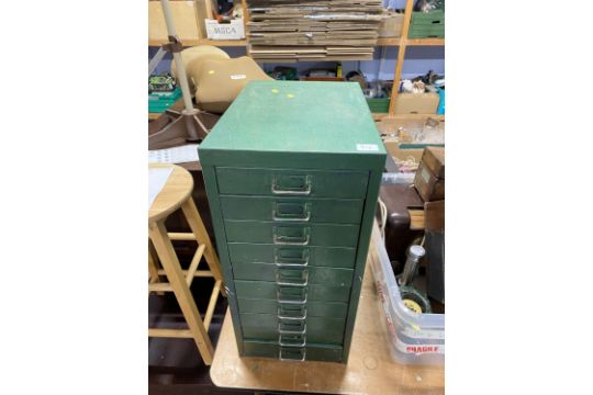 A green ten shelf tool box, with various assorted contents