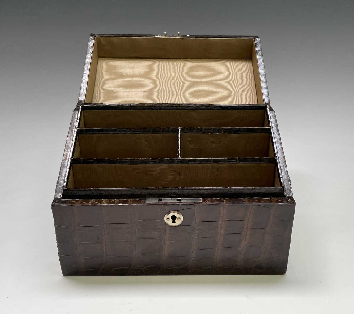 An Asprey crocodile hide covered stationery box with green silk fitted ...