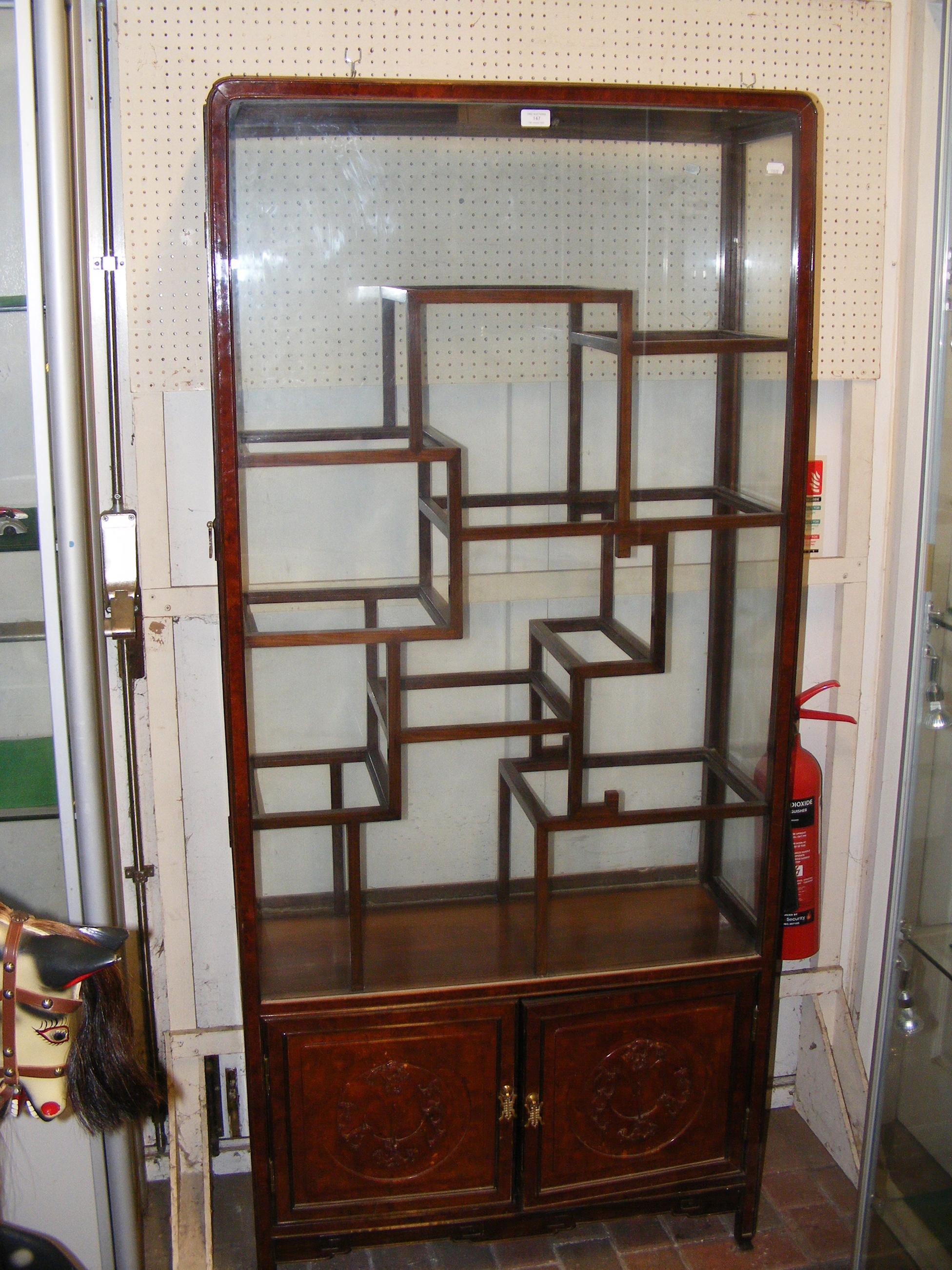 An unusual Oriental glazed display cabinet with cupboards below - 82cm wide