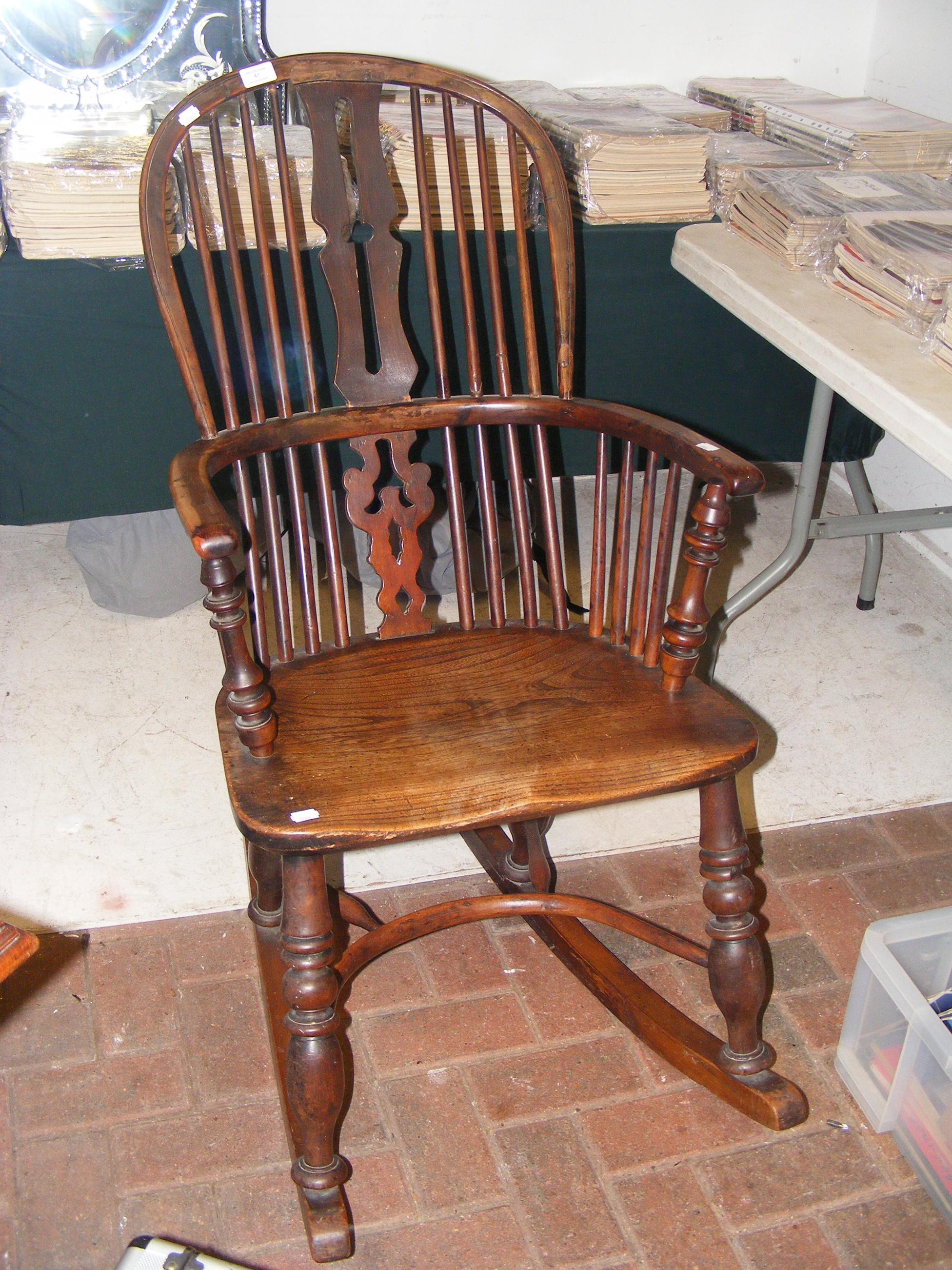An antique stick back rocking chair