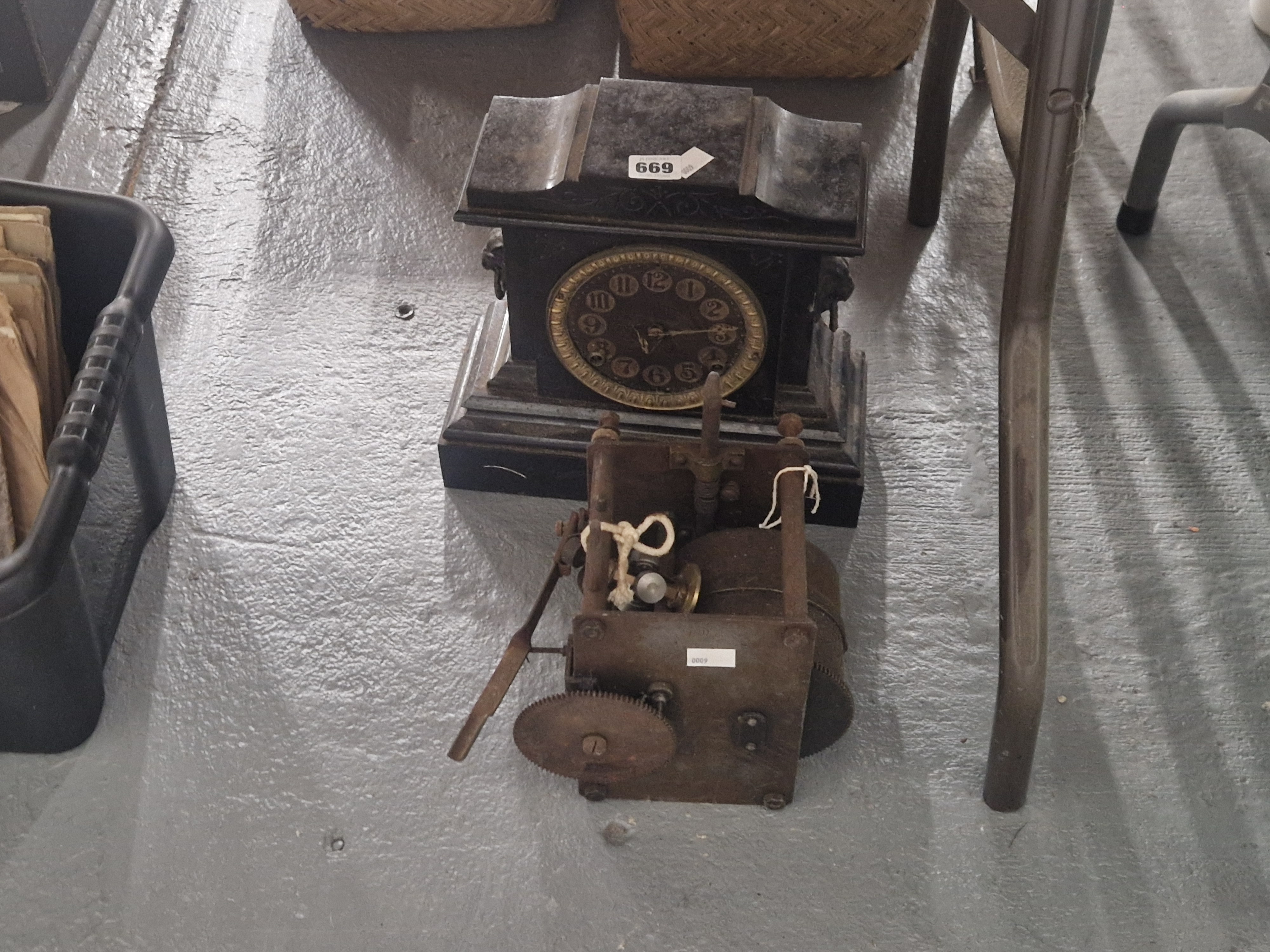 A black slated cased mantle clock together with a clockwork motor