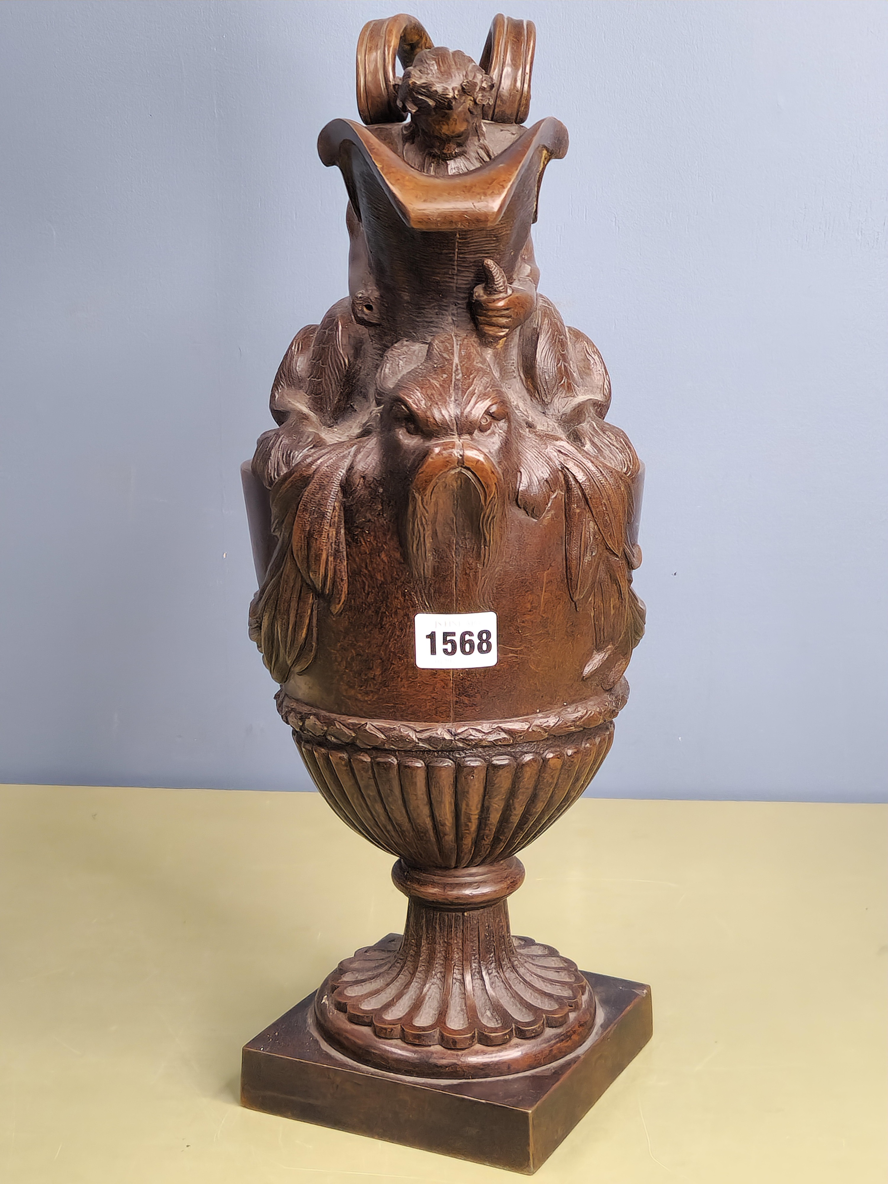 A 19th century bronze baluster ewer with a merman handle and a swagged ...