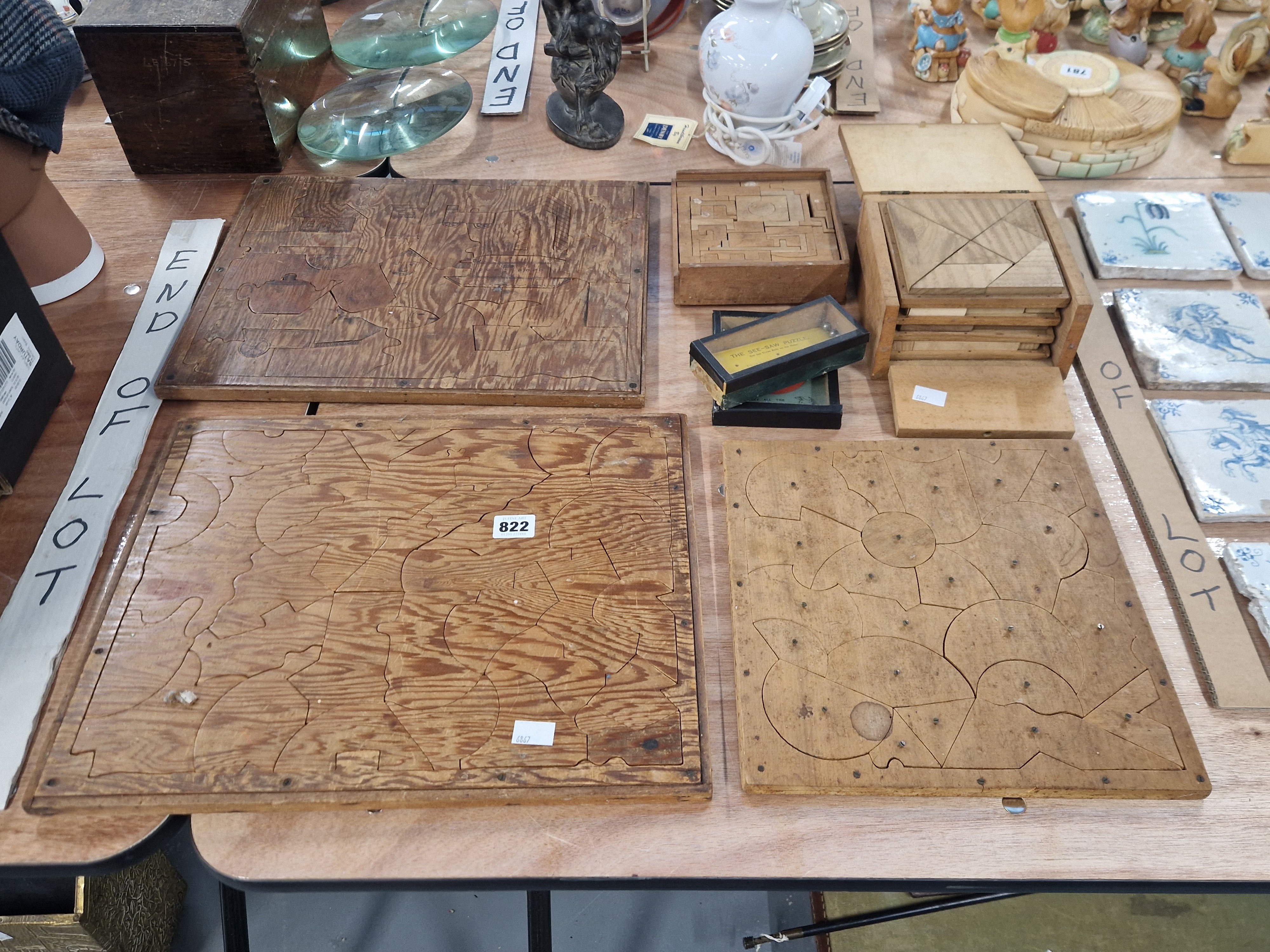 A collection of wooden jigsaw puzzles together with two ball bearing games