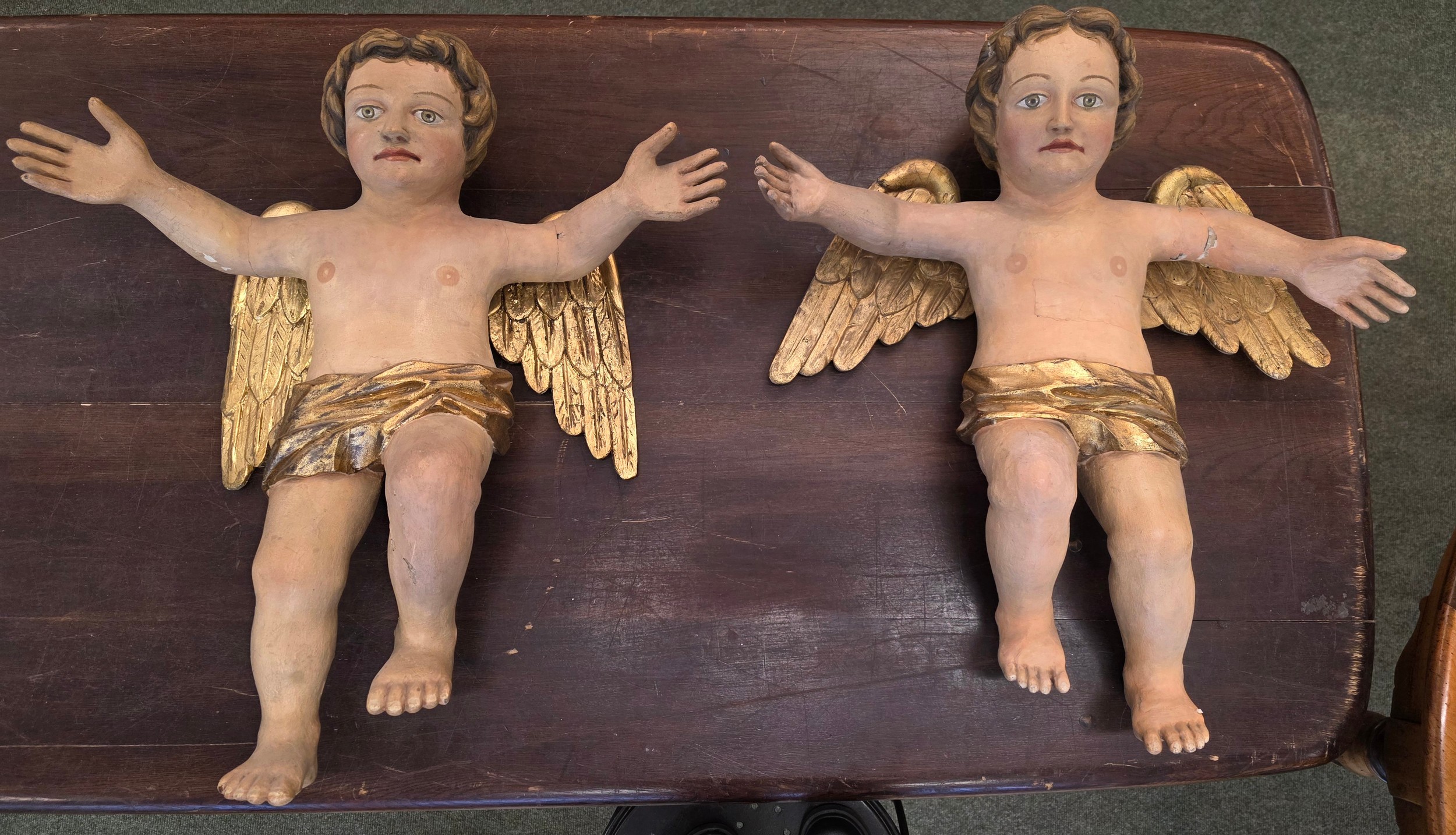 A pair of winged putti cherubs, from Poland, both with some breaks and ...