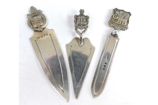 Three Edwardian silver armorial clip bookmarks, comprising one with ...