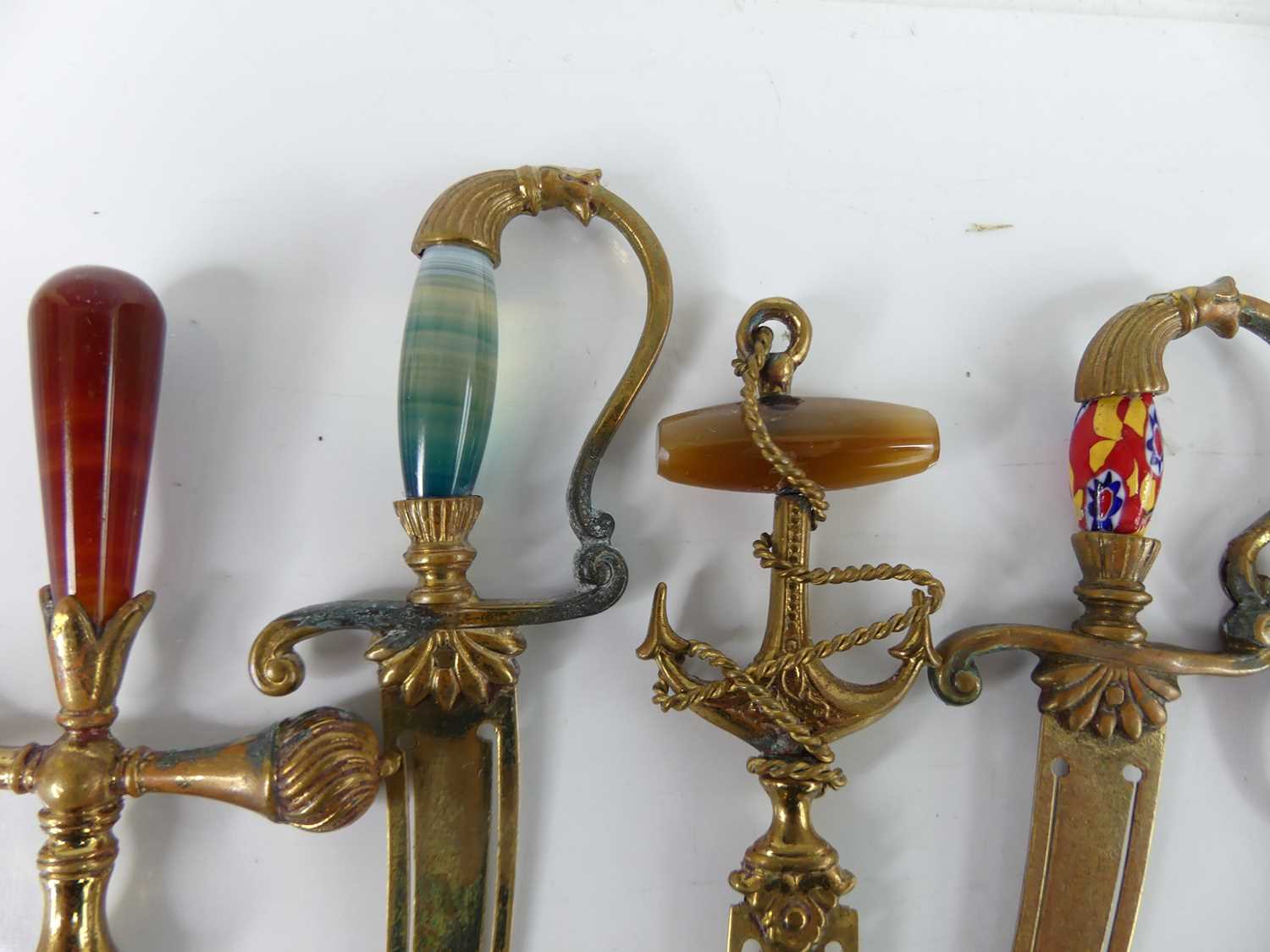 Three Victorian brass novelty bookmarks in the form of sabres, two ...