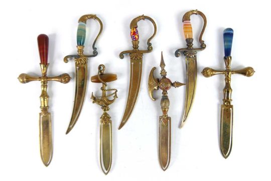 Three Victorian brass novelty bookmarks in the form of sabres, two ...