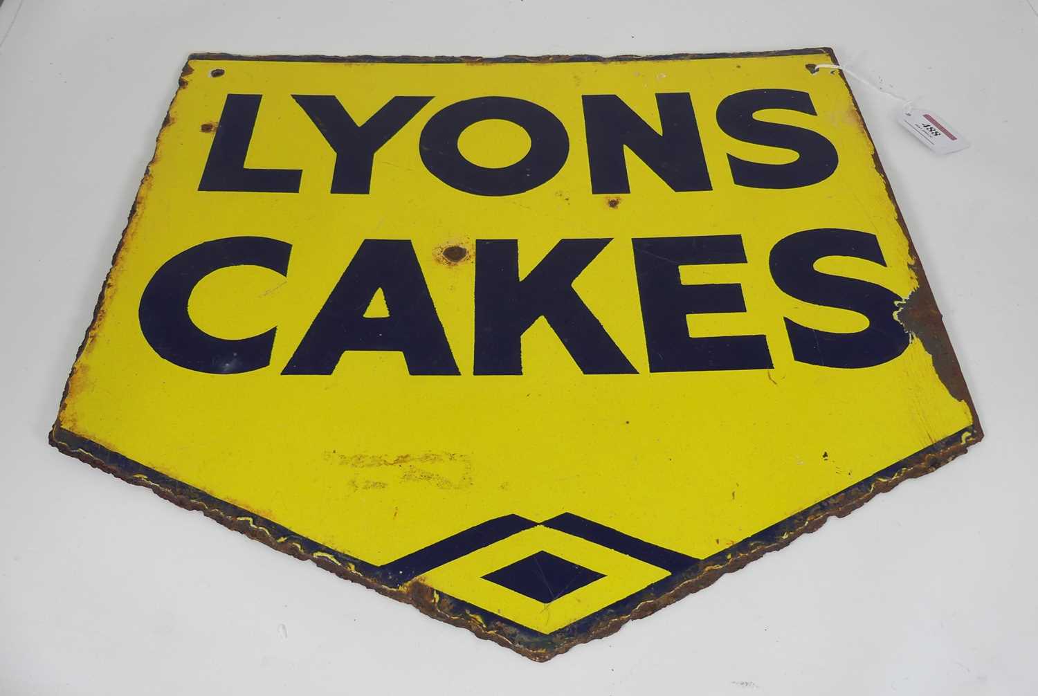 A double-sided enamel on metal advertising sign for Lyons Cakes, of ...