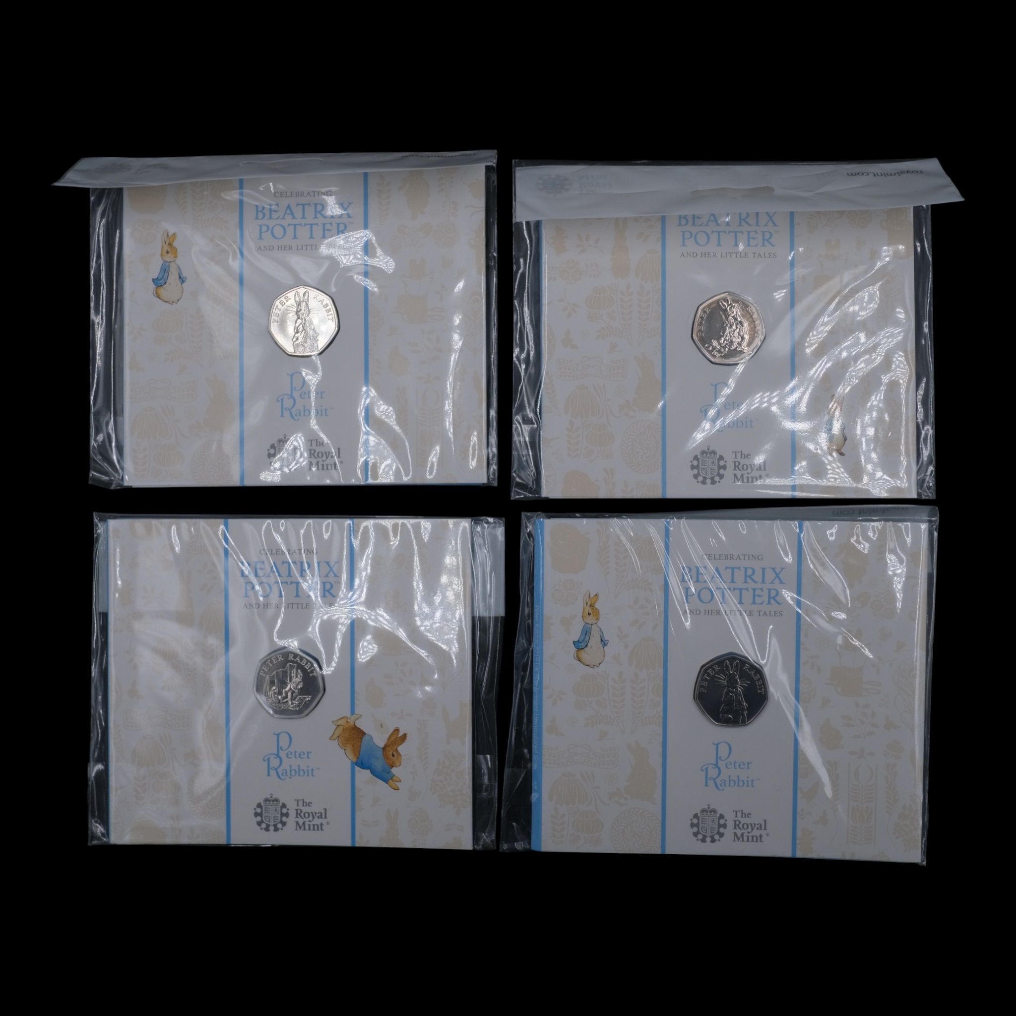 Sixteen Royal Mint BUNC 50p coin packs, including Sherlock Homes, Peter ...