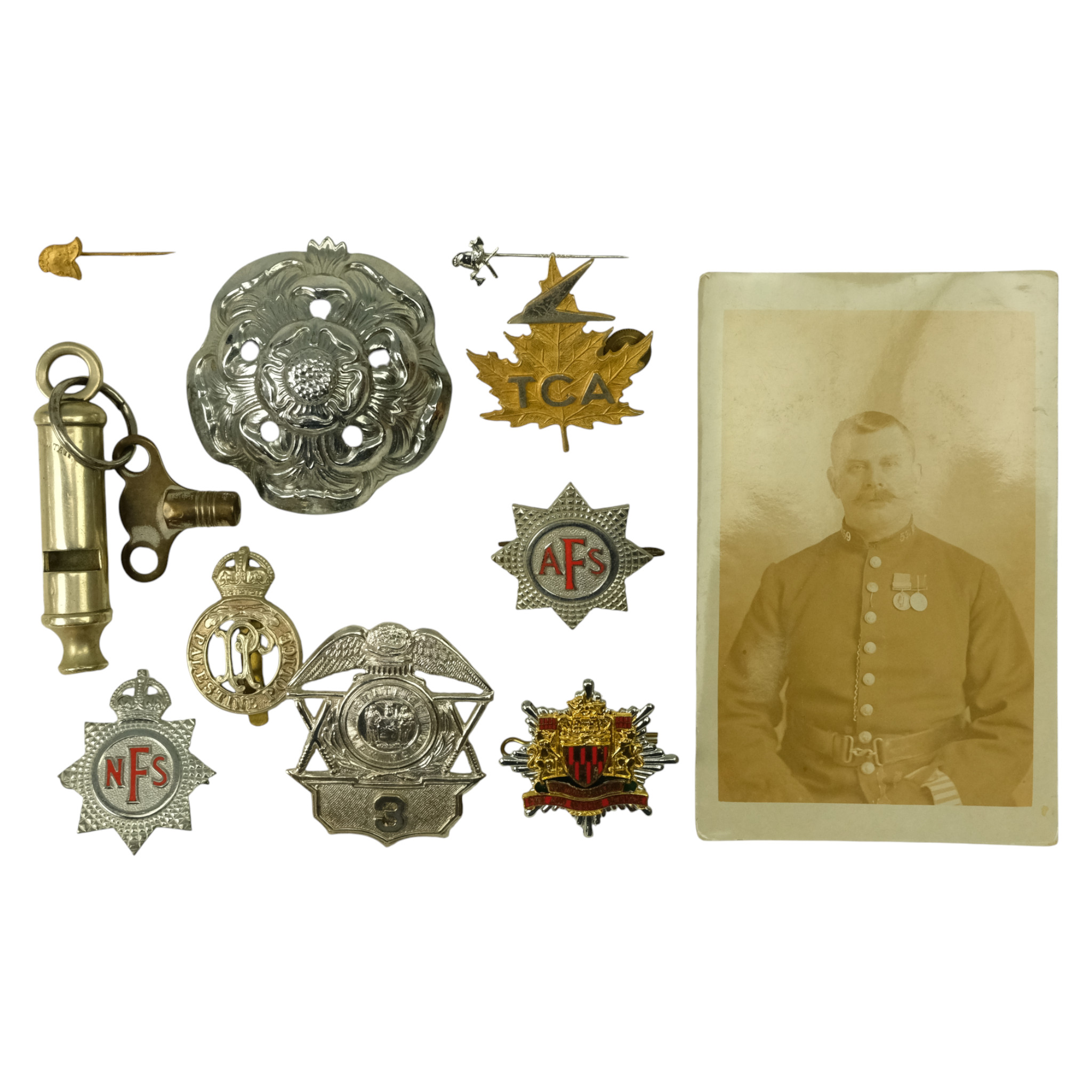 A group of Police and Fire Brigade cap badges etc