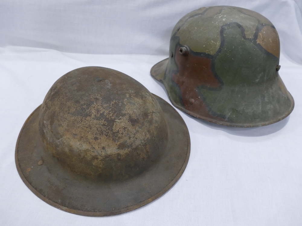 A German World War I camouflage helmet (no liner) and a World War II ...