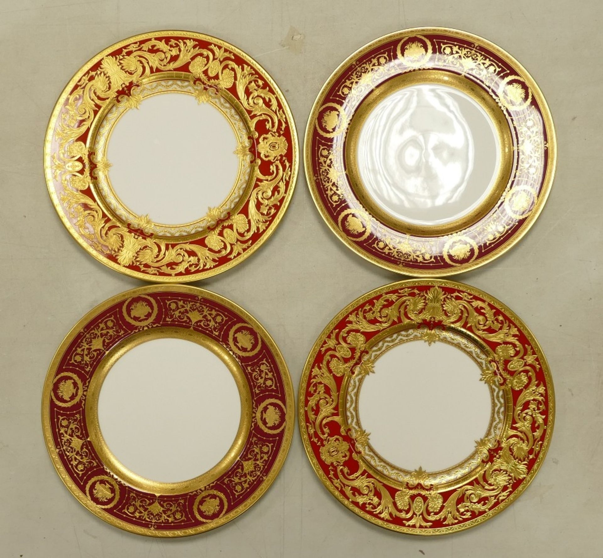 De Lamerie Fine Bone China, a selection of heavily gilt plates in ...