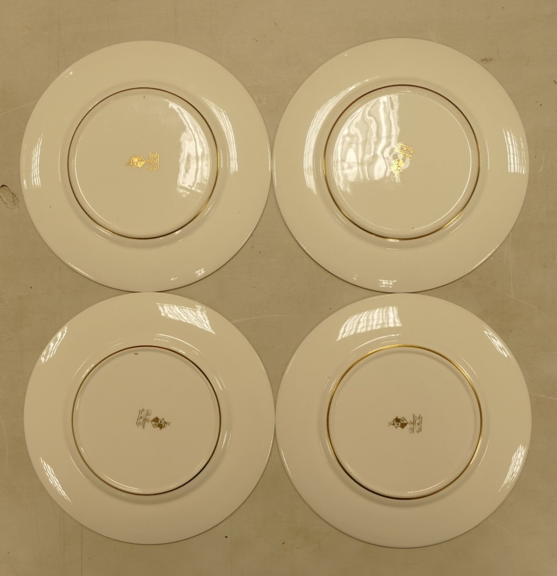 De Lamerie Fine Bone China, a selection of heavily gilt plates in ...