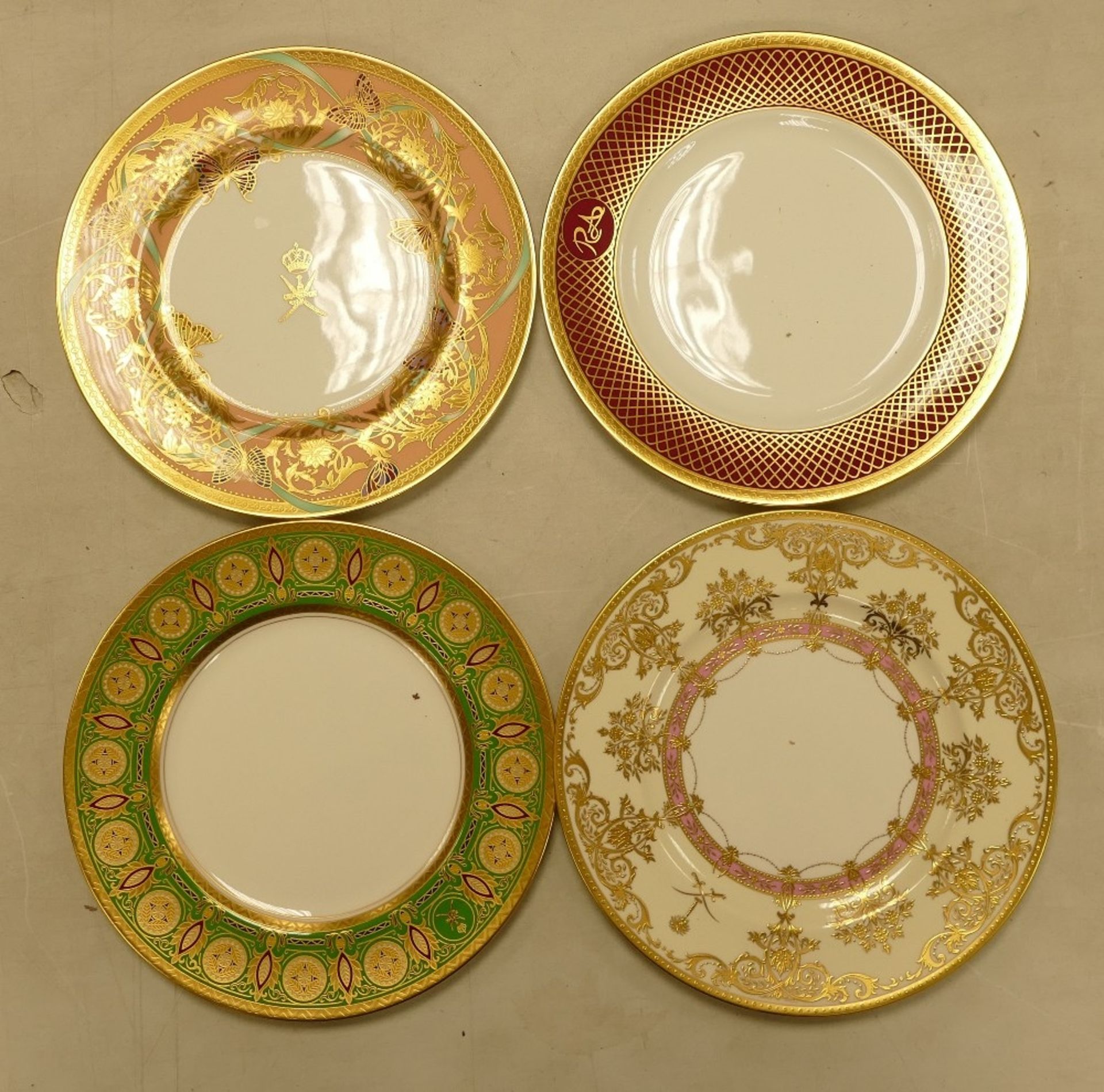De Lamerie Fine Bone China, a selection of heavily gilt plates in ...