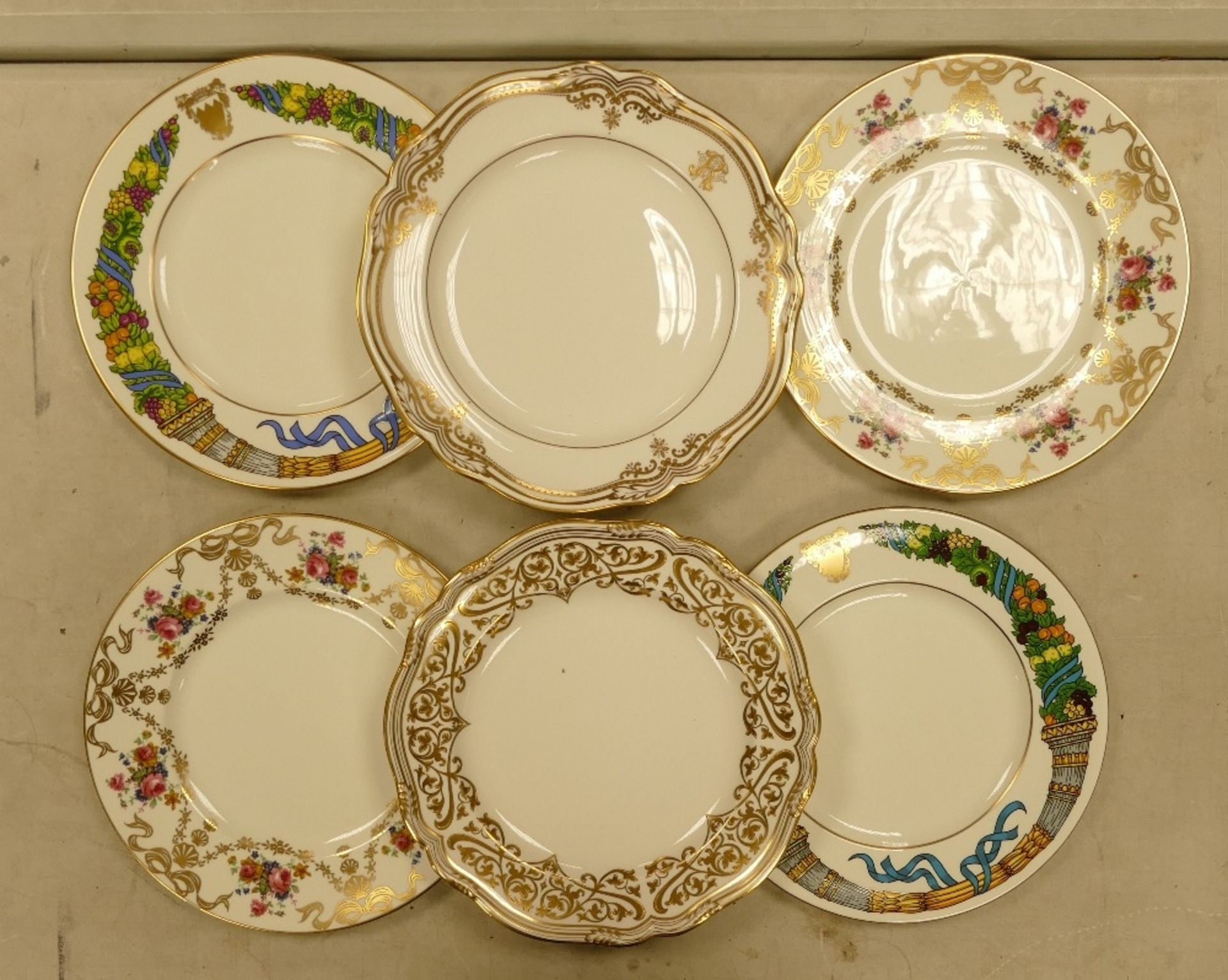 De Lamerie Fine Bone China, a selection of heavily gilt plates in ...