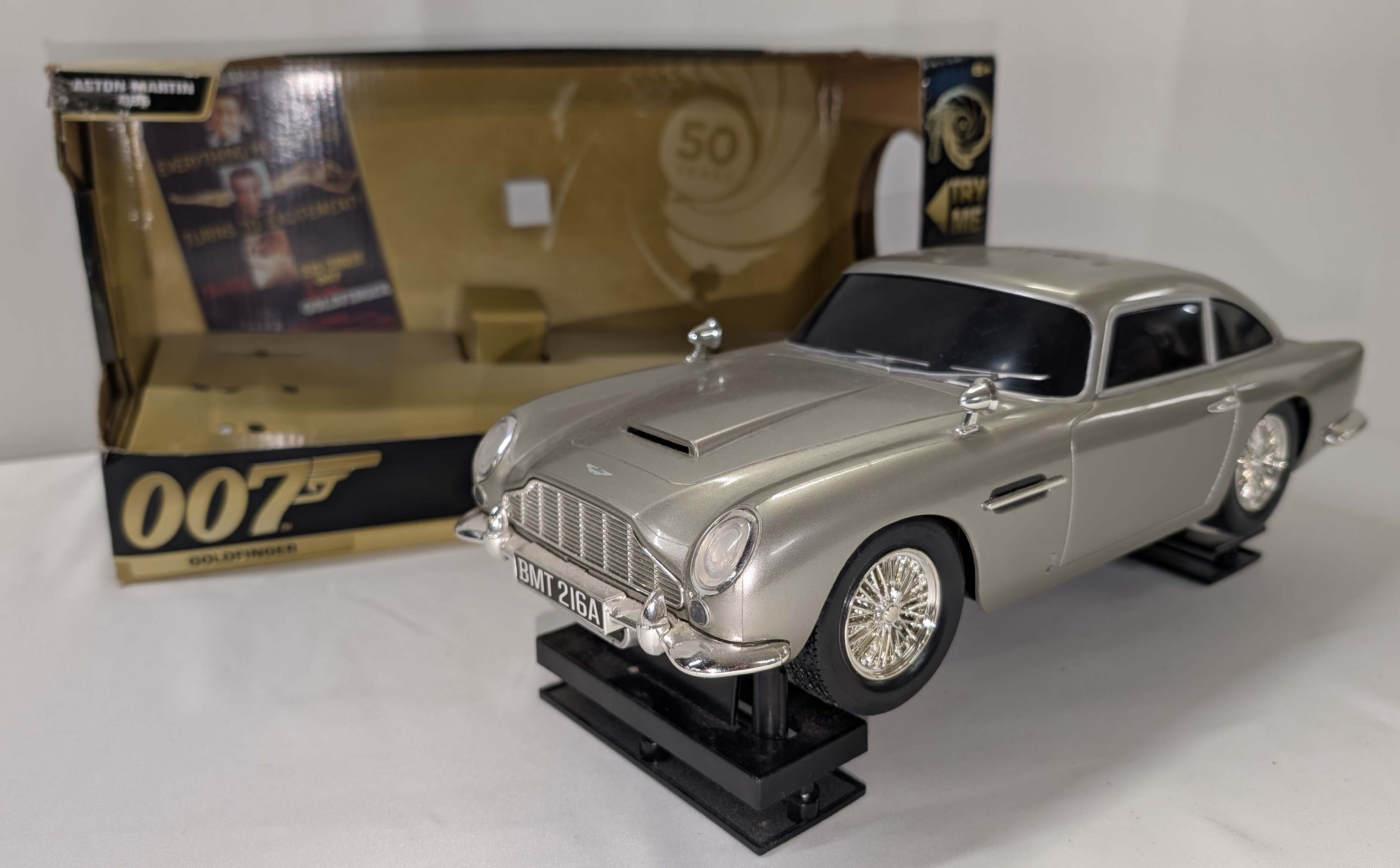 A James Bond Goldfinger plastic scale model car, motorised with lights ...