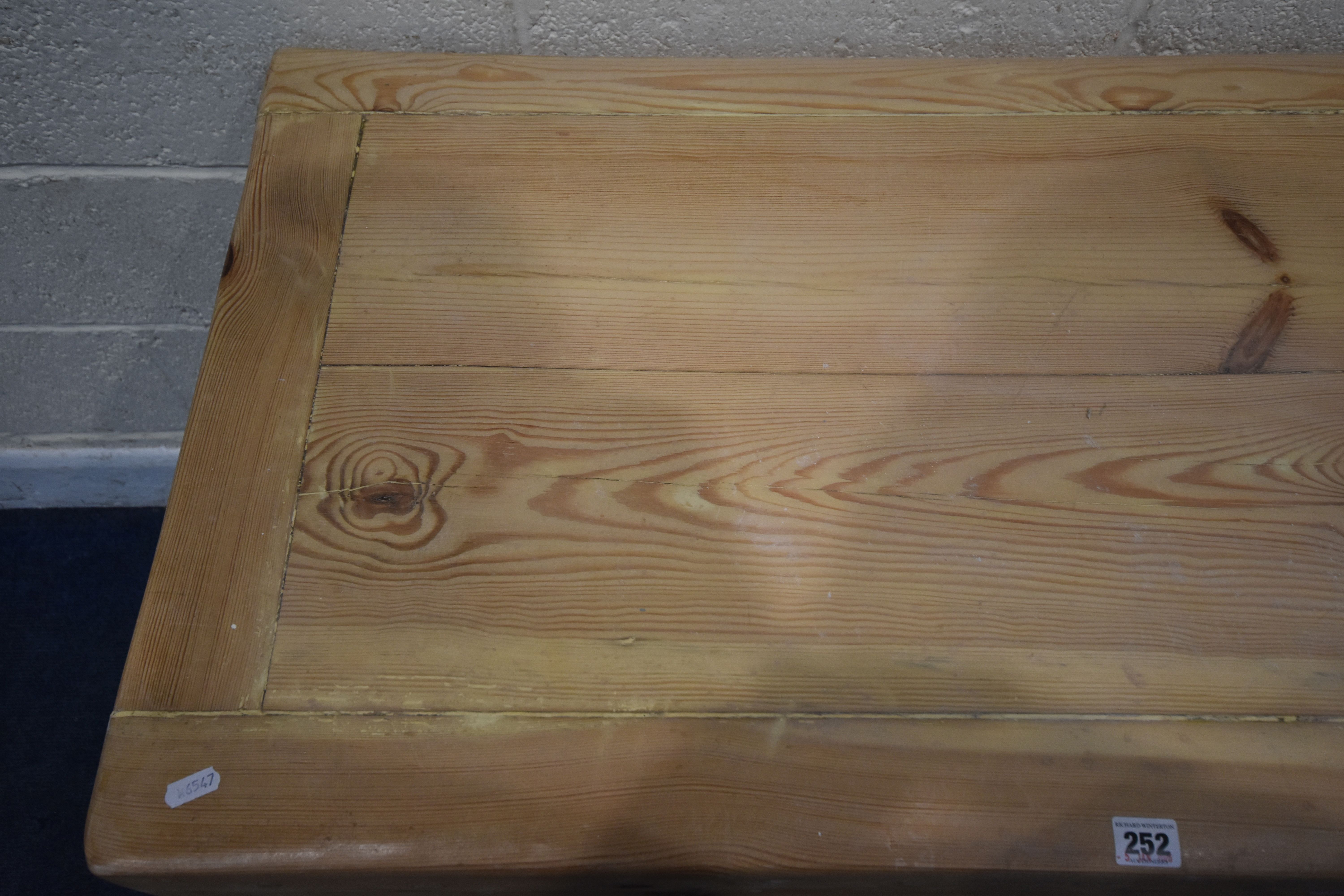 A SCRATCH BUILT BUTCHERS BLOCK, raised on block legs, united by ...