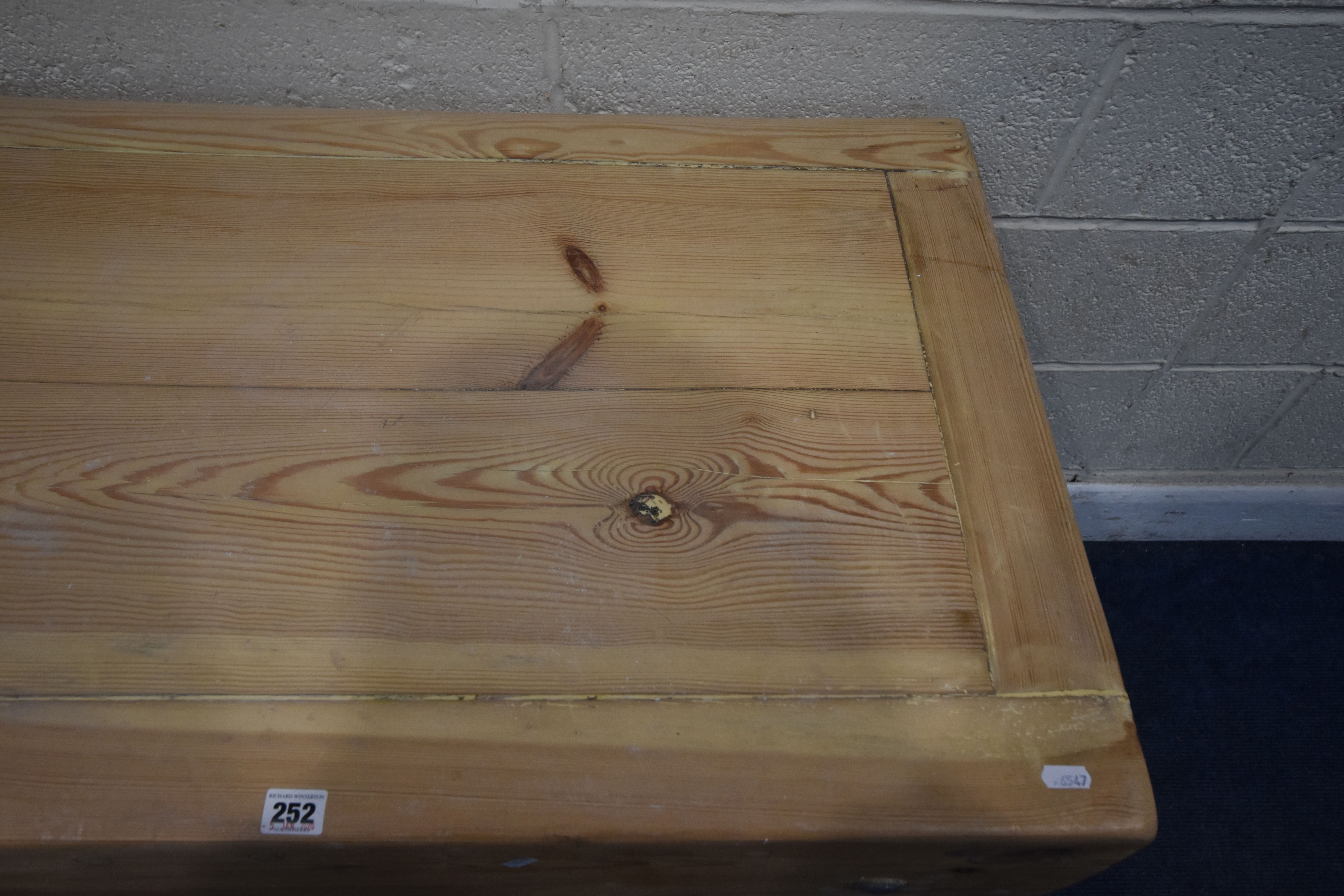 A SCRATCH BUILT BUTCHERS BLOCK, raised on block legs, united by ...