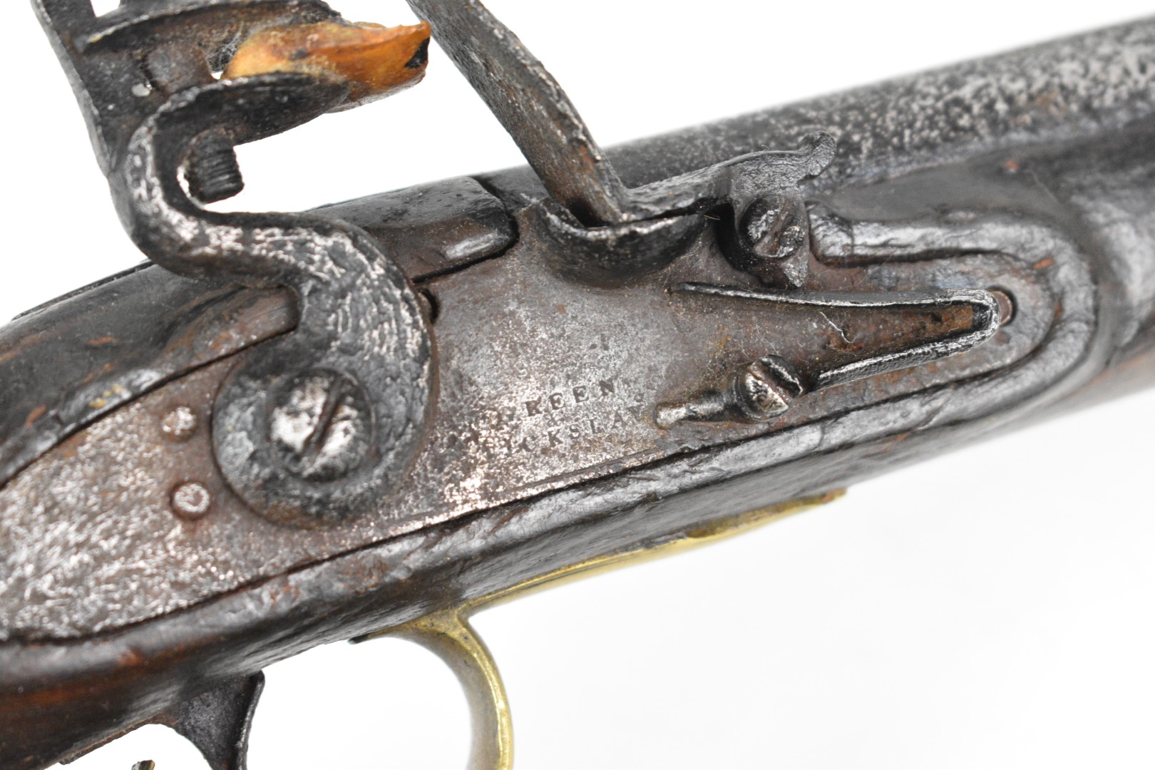 Two flintlock pistols one with indistinctly named lock, engraved brass ...