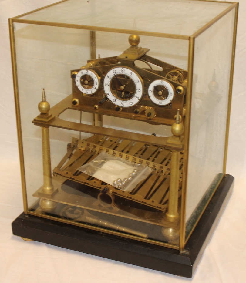 An unusual brass Congreve ball bearing balance clock with three enamel ...