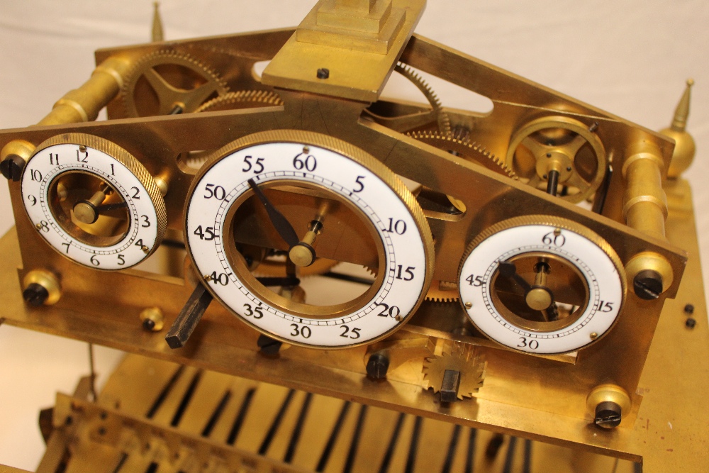 An unusual brass Congreve ball bearing balance clock with three enamel ...