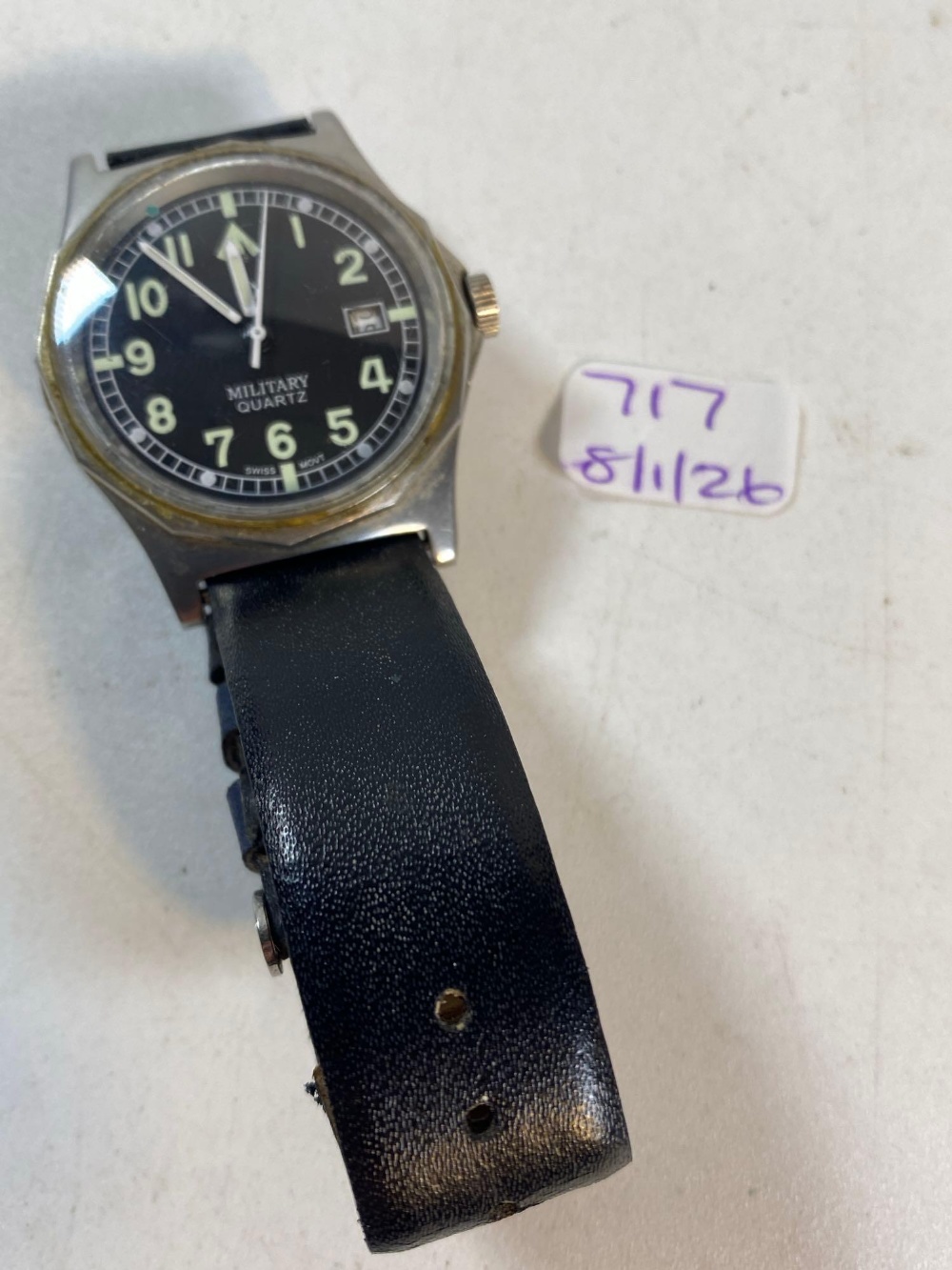 A military style wrist watch with seconds sweep and date aperture