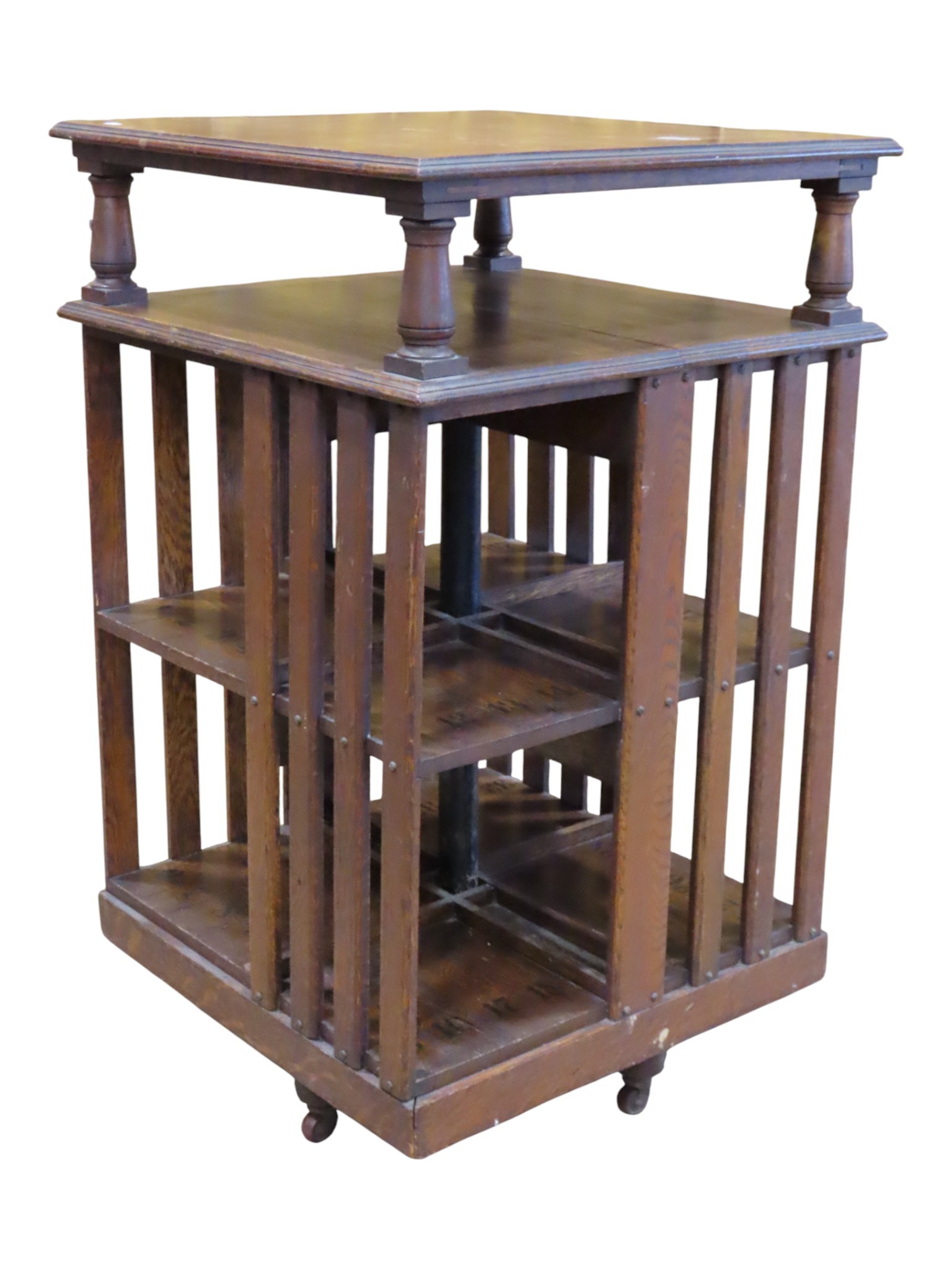 A substantial oak revolving library bookcase of traditional form with ...
